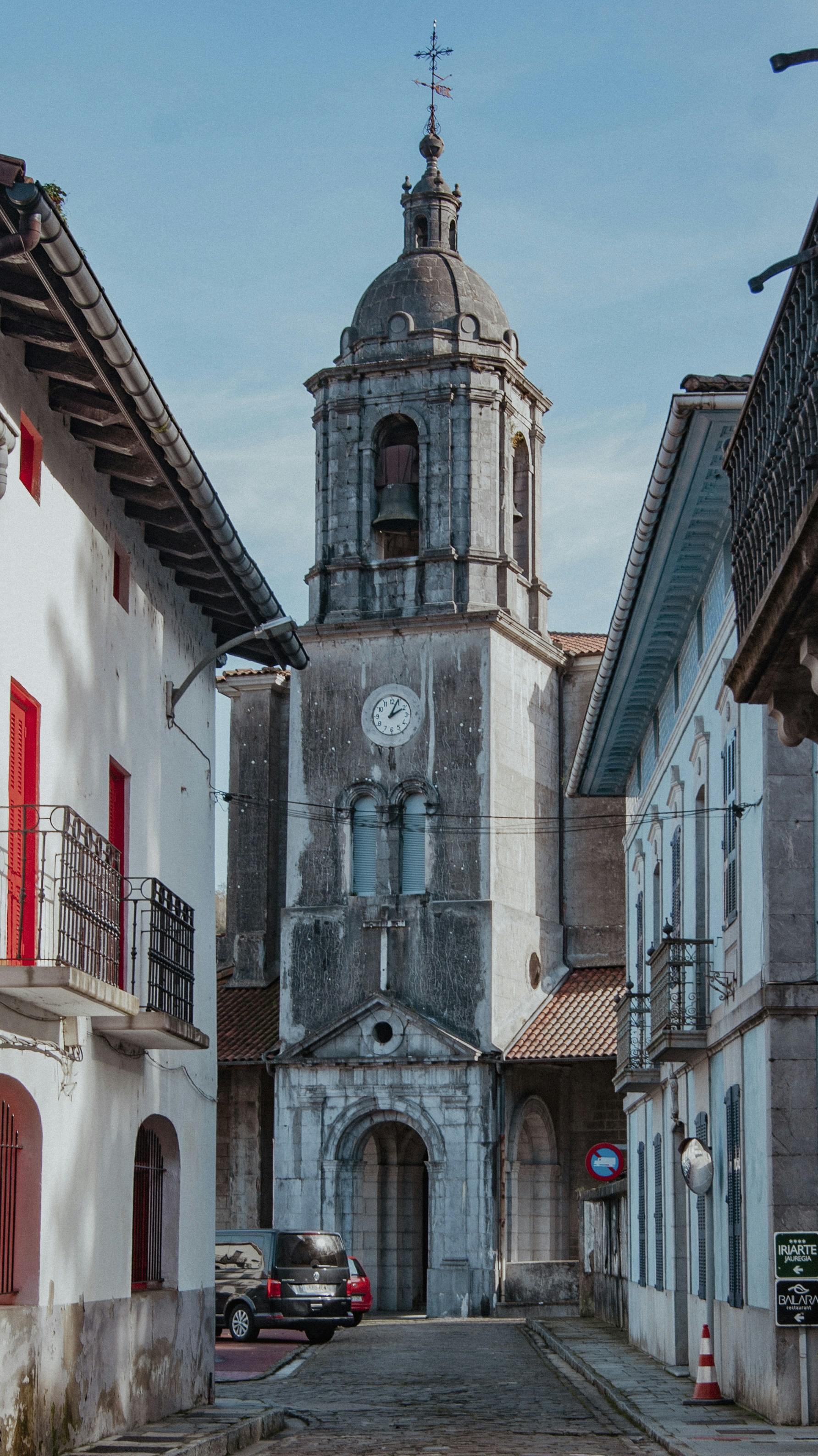 A church stands at the end of a street.
