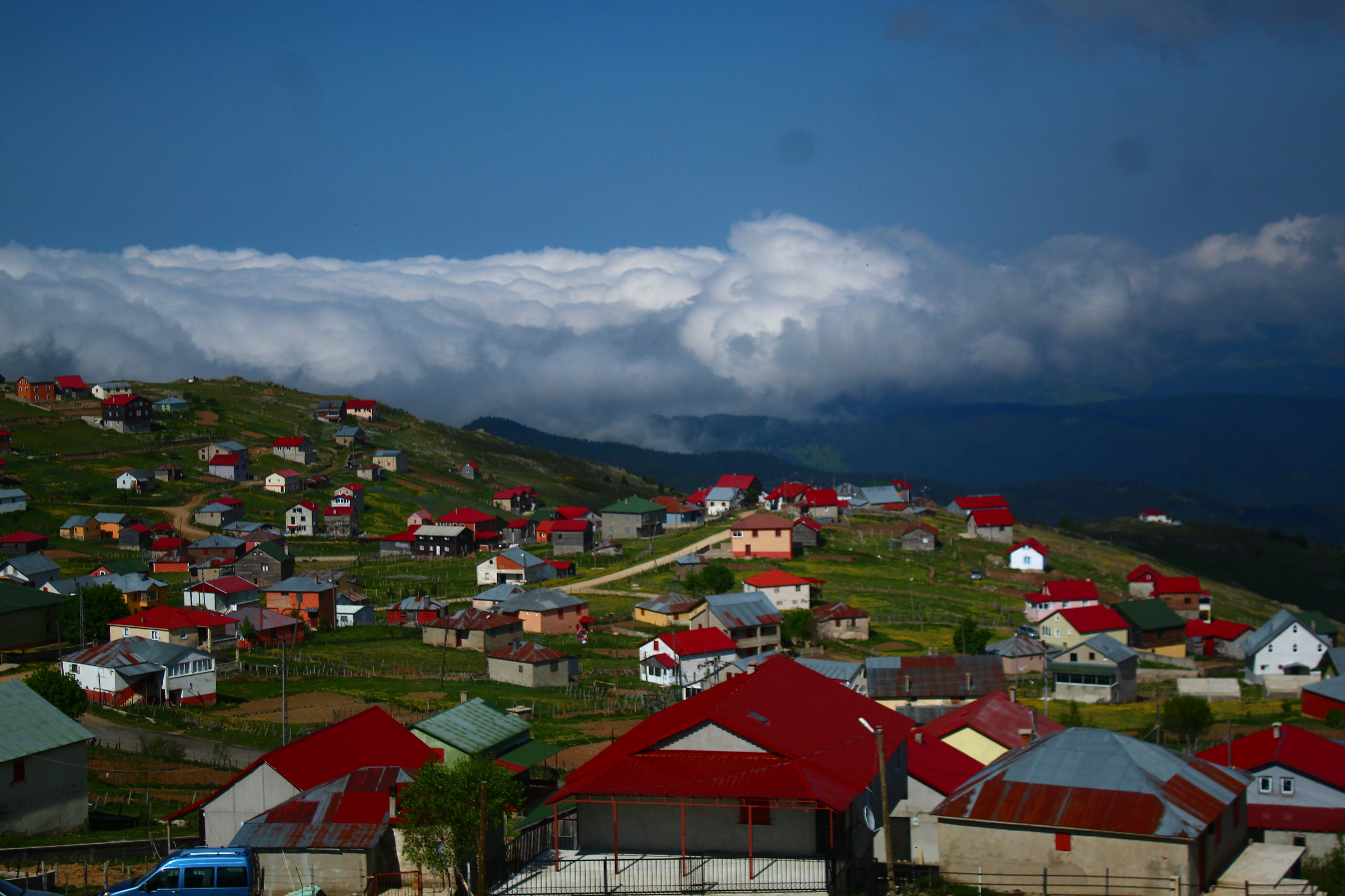Rooftops and Rolling Clouds: A Village Tapestry