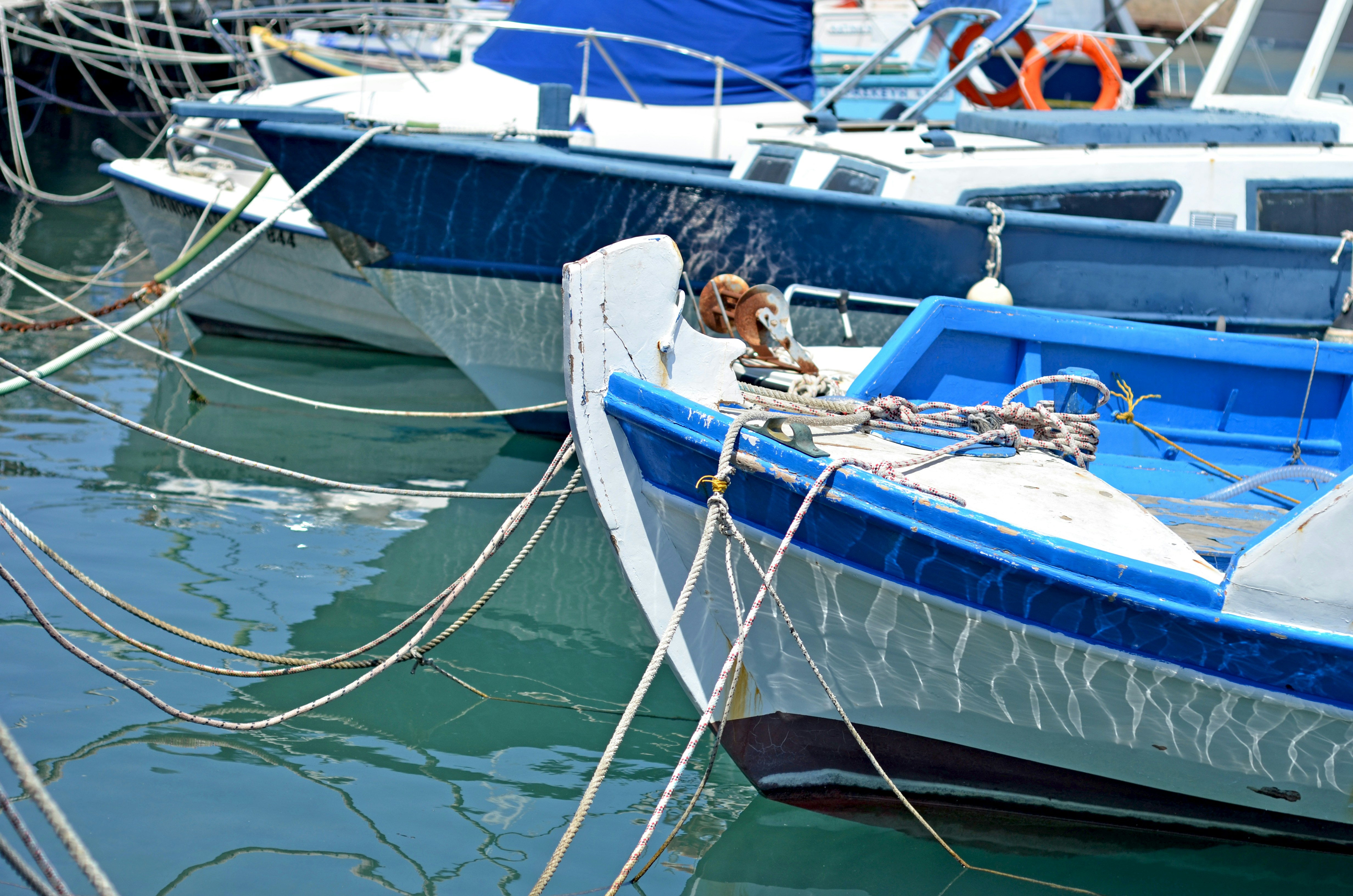Boats are docked in the harbor, tied with ropes. photo – Free Sea Image ...