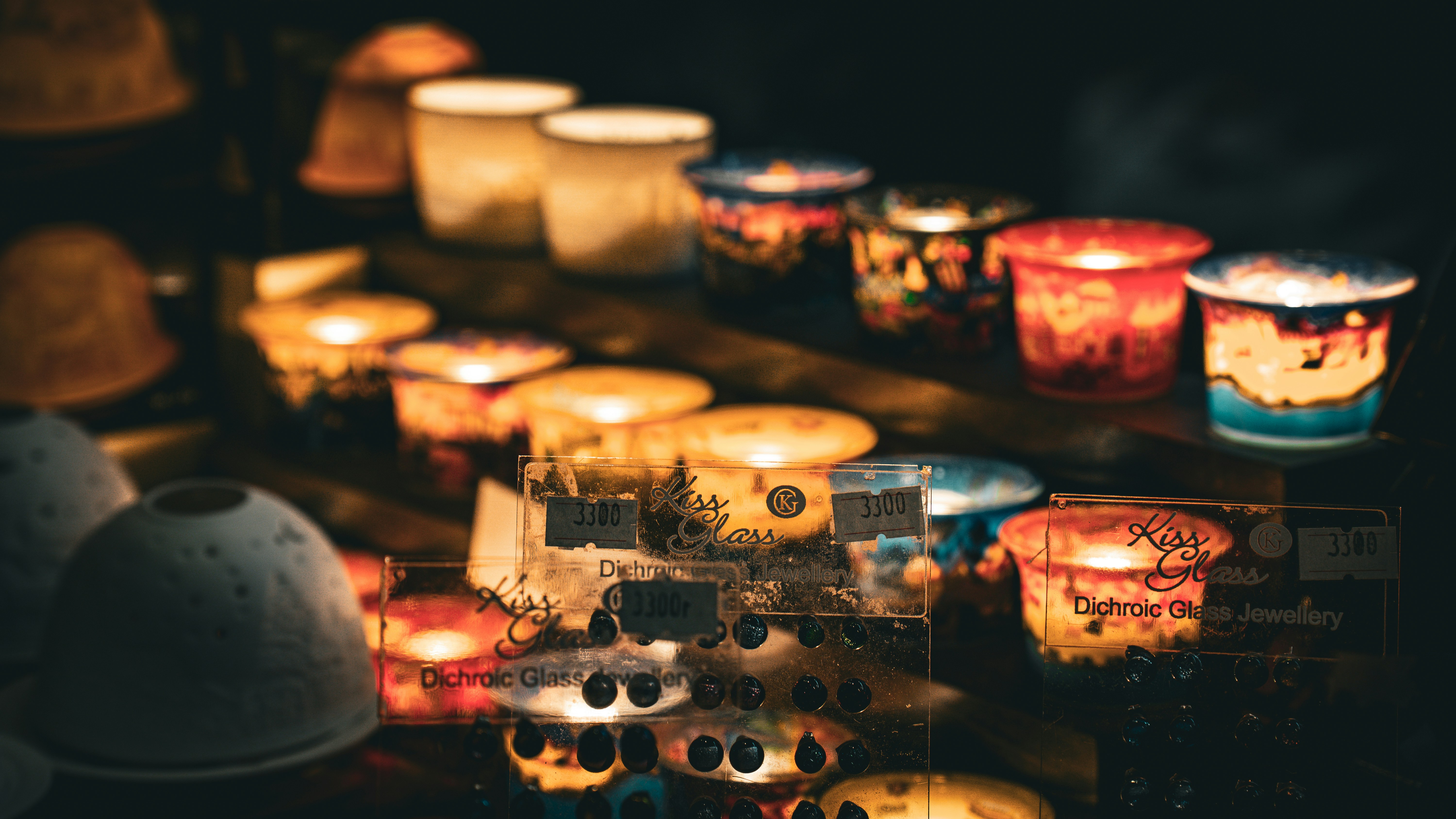 Glowing candles illuminate a dark room.