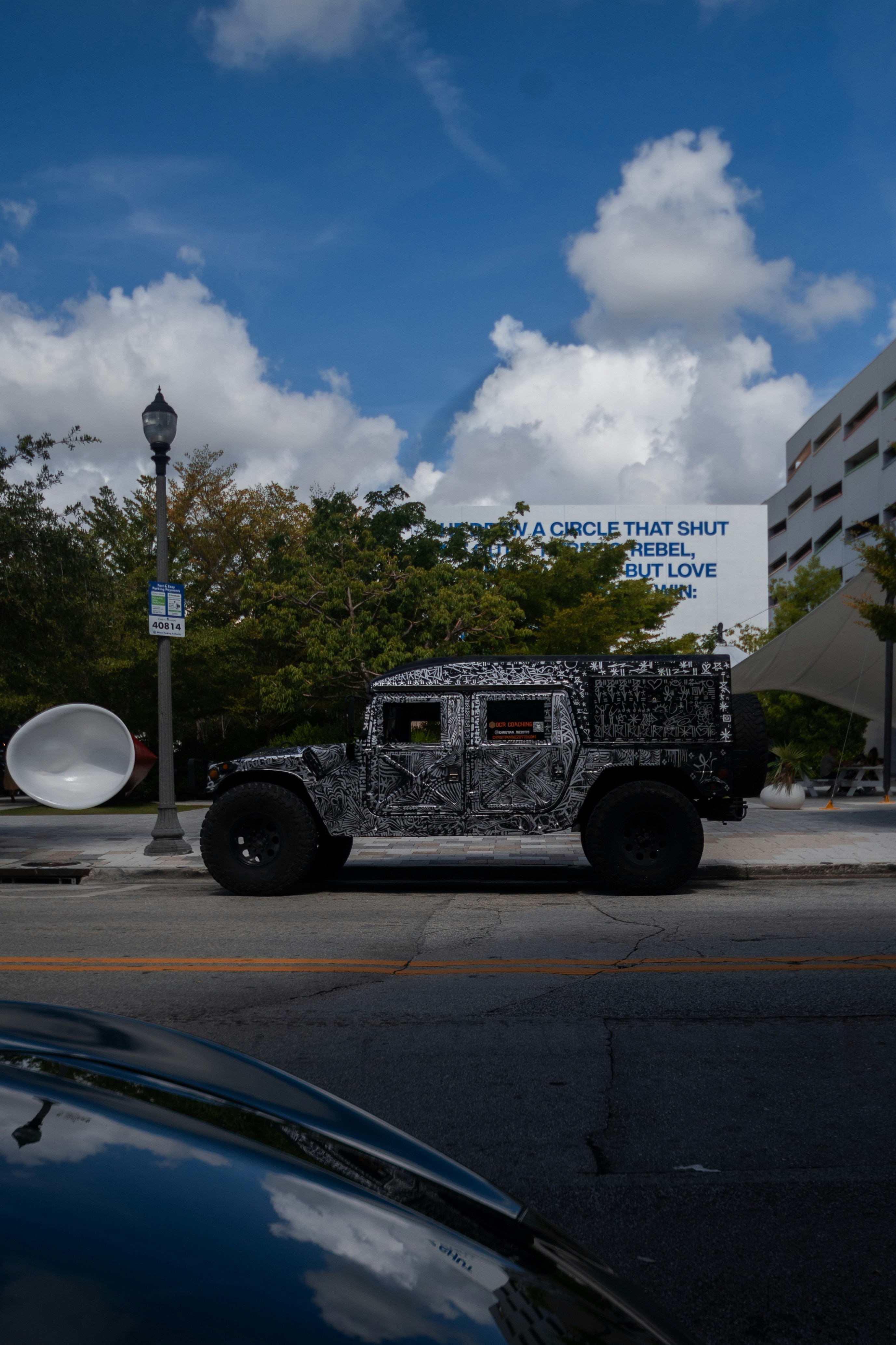 A camouflaged humvee is parked on a street. photo – Free Car Image on ...
