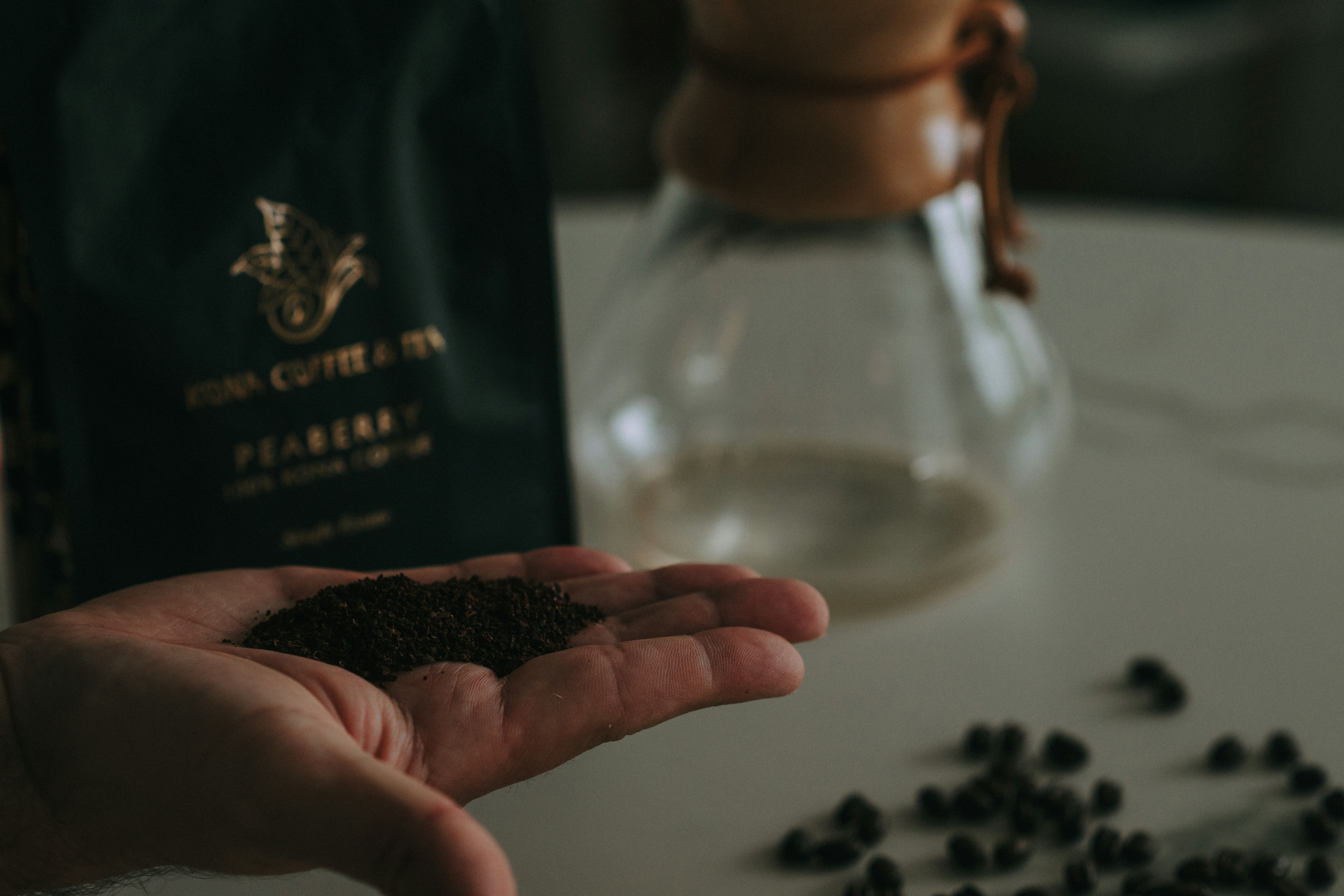 Fresh coffee grounds in a hand.