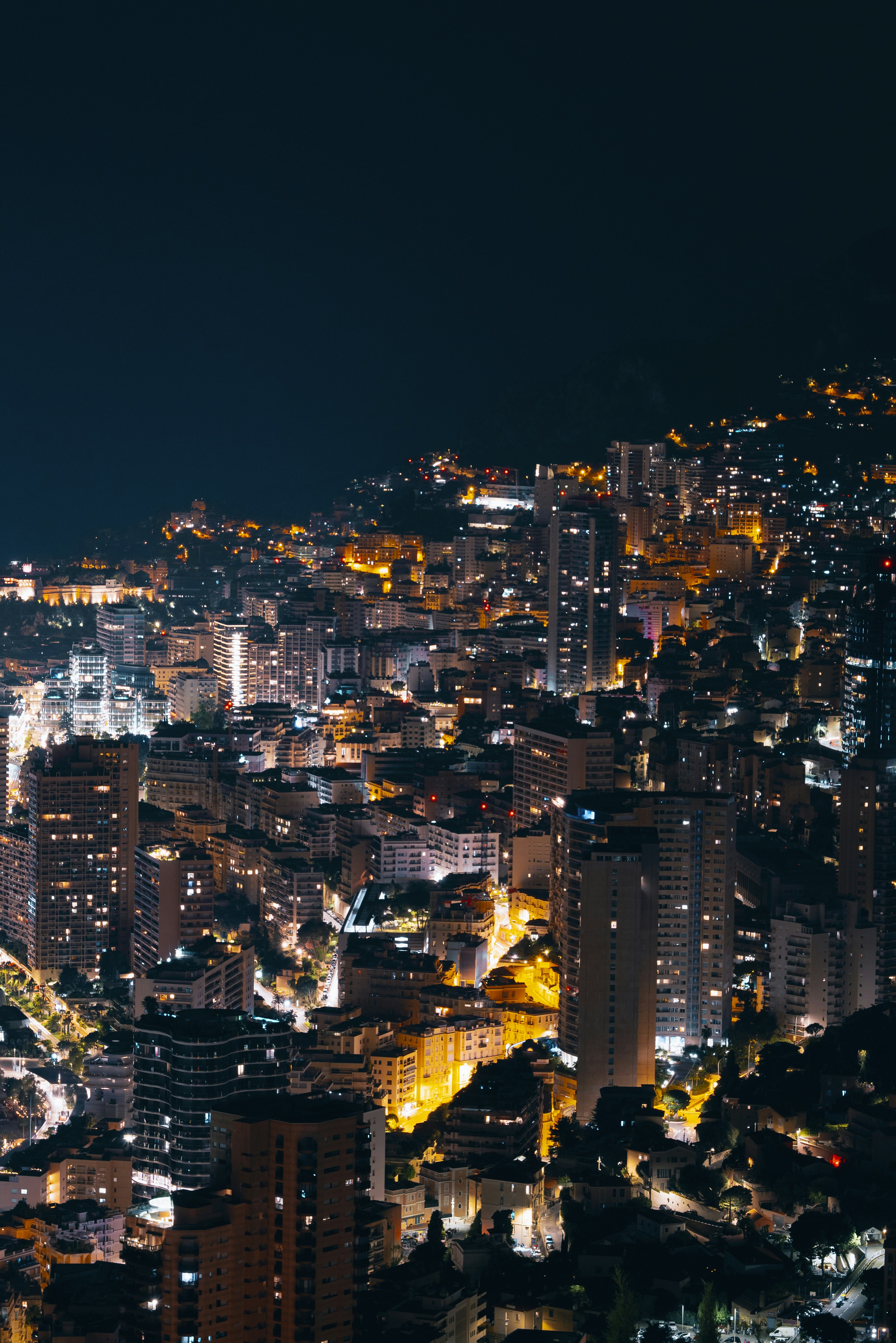 Nighttime cityscape illuminated with city lights.