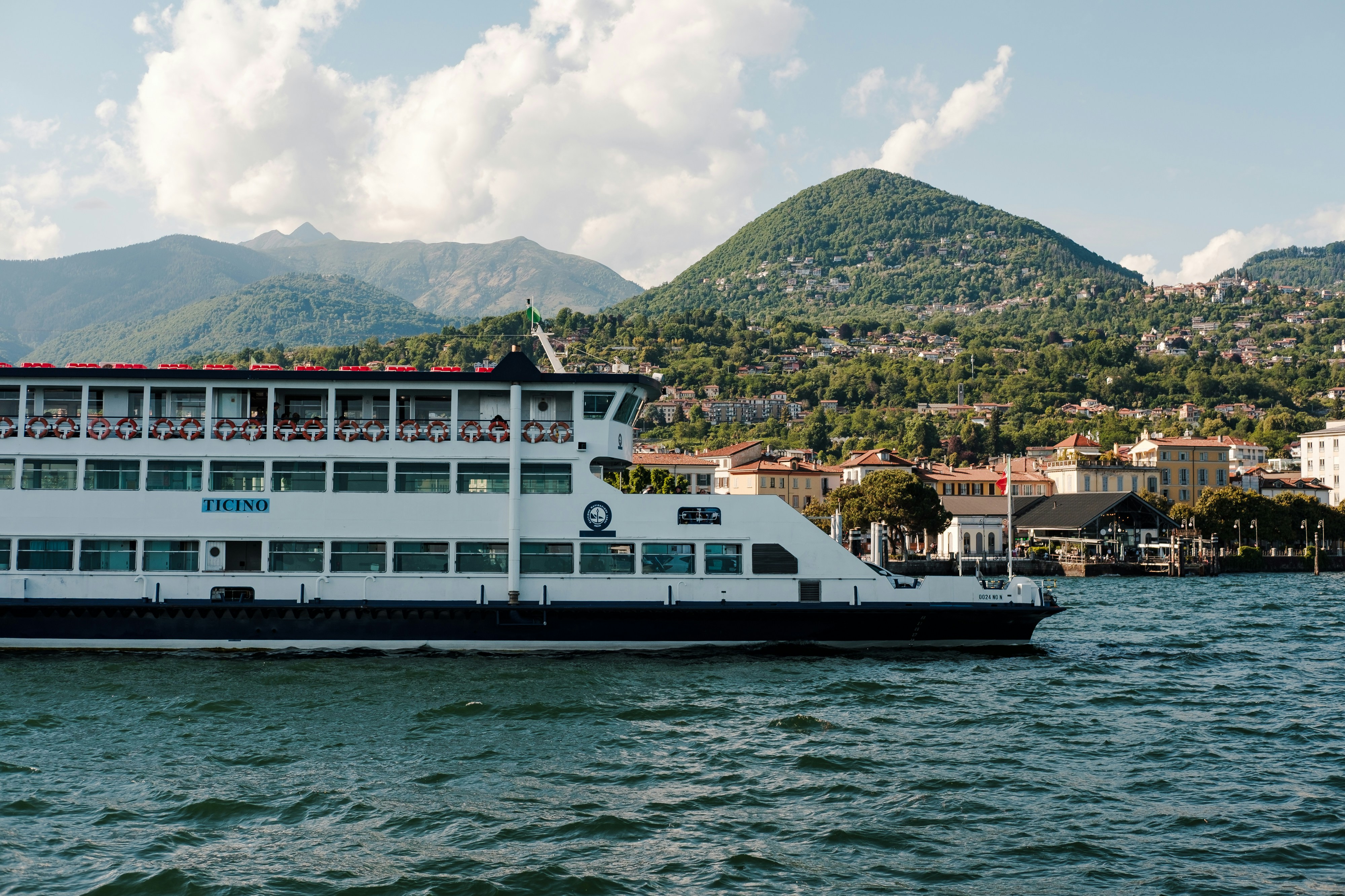 A ferry sails across the water towards a town. photo – Free Ferry Image ...