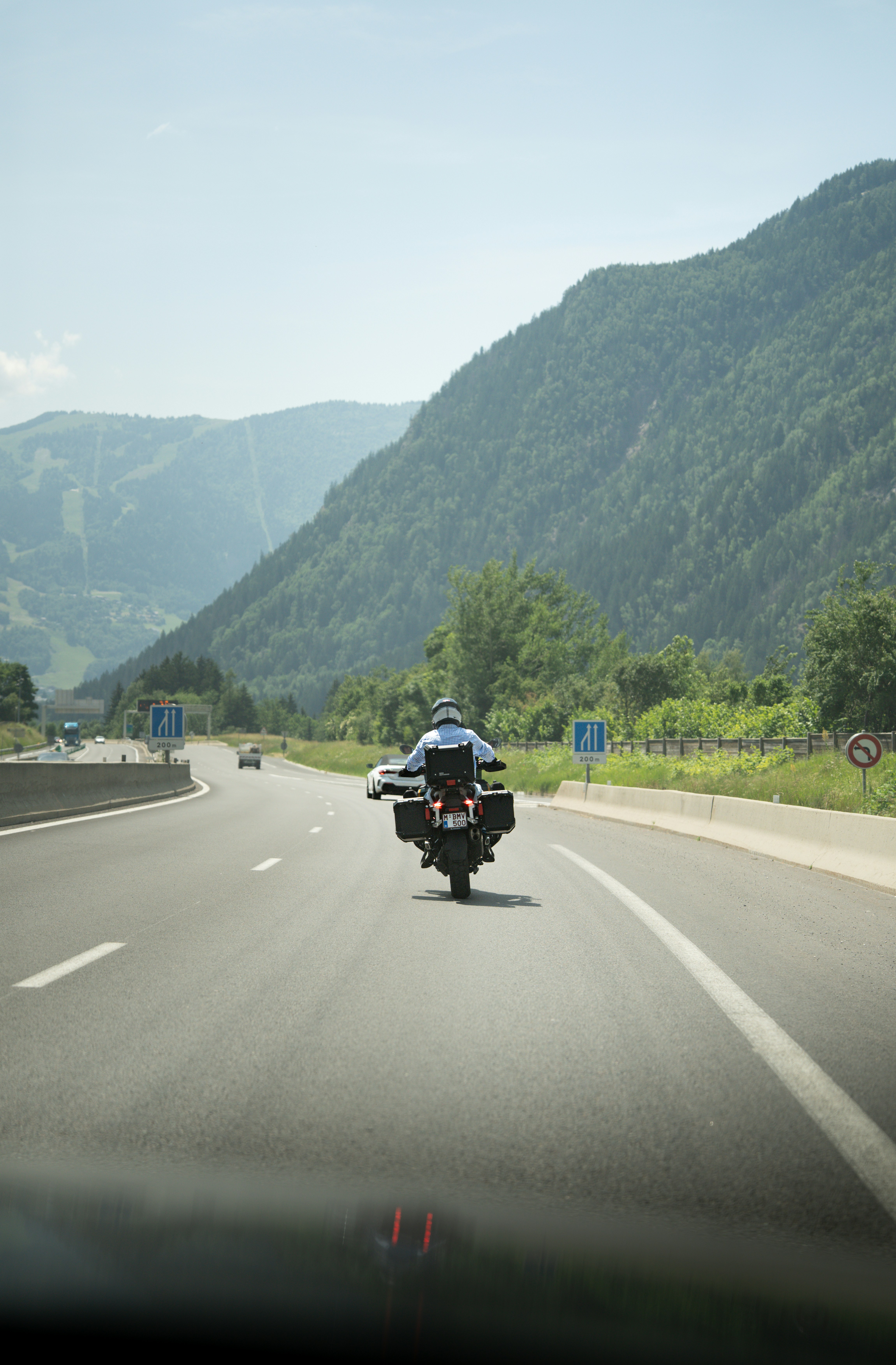Alpine Ribbon: A lone rider carves a quiet line through sunlit valley