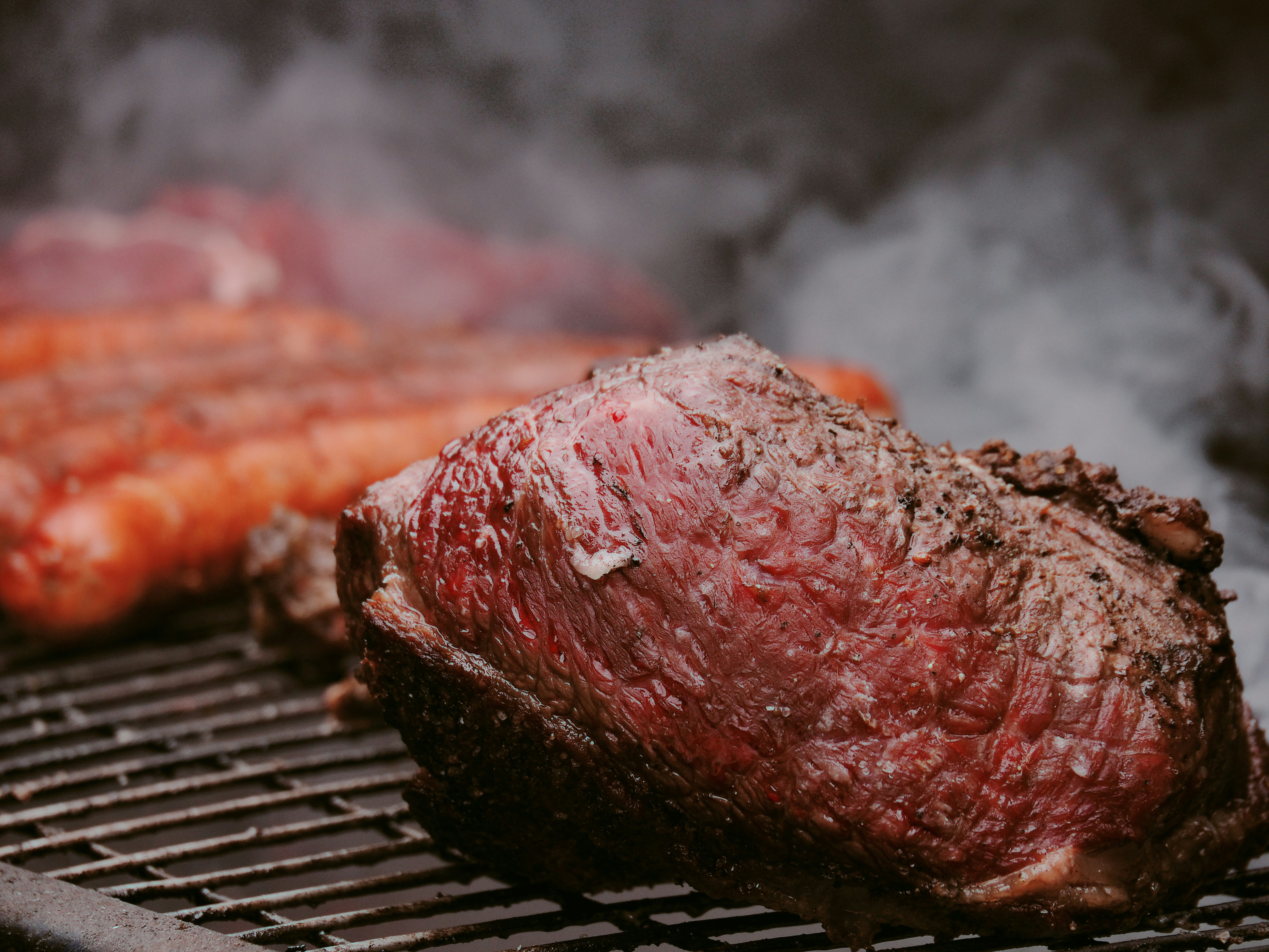 The most delicious barbecue in the world 🍖 | Steak and carrots sizzling on a grill.