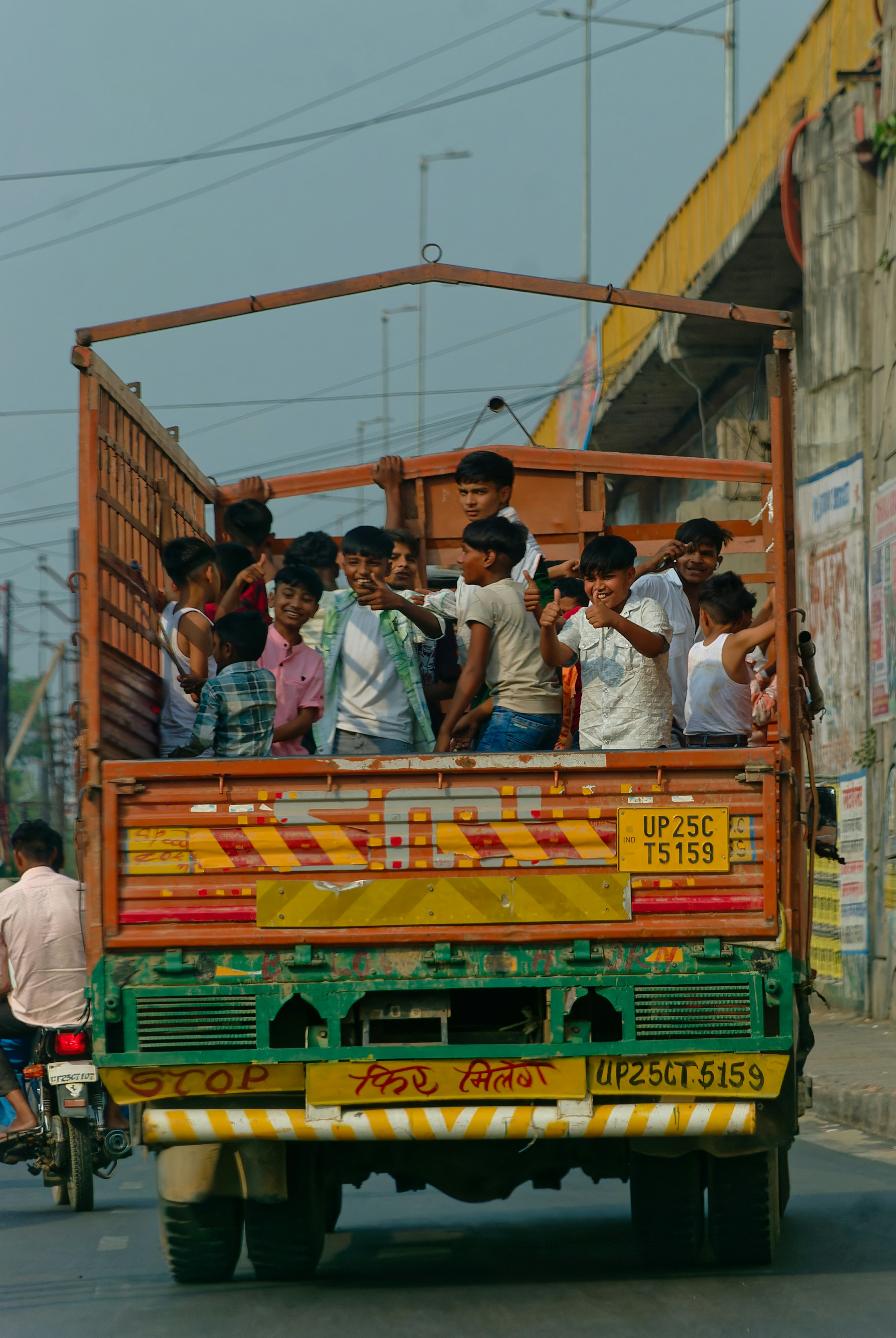 Children are packed in the back of a truck.