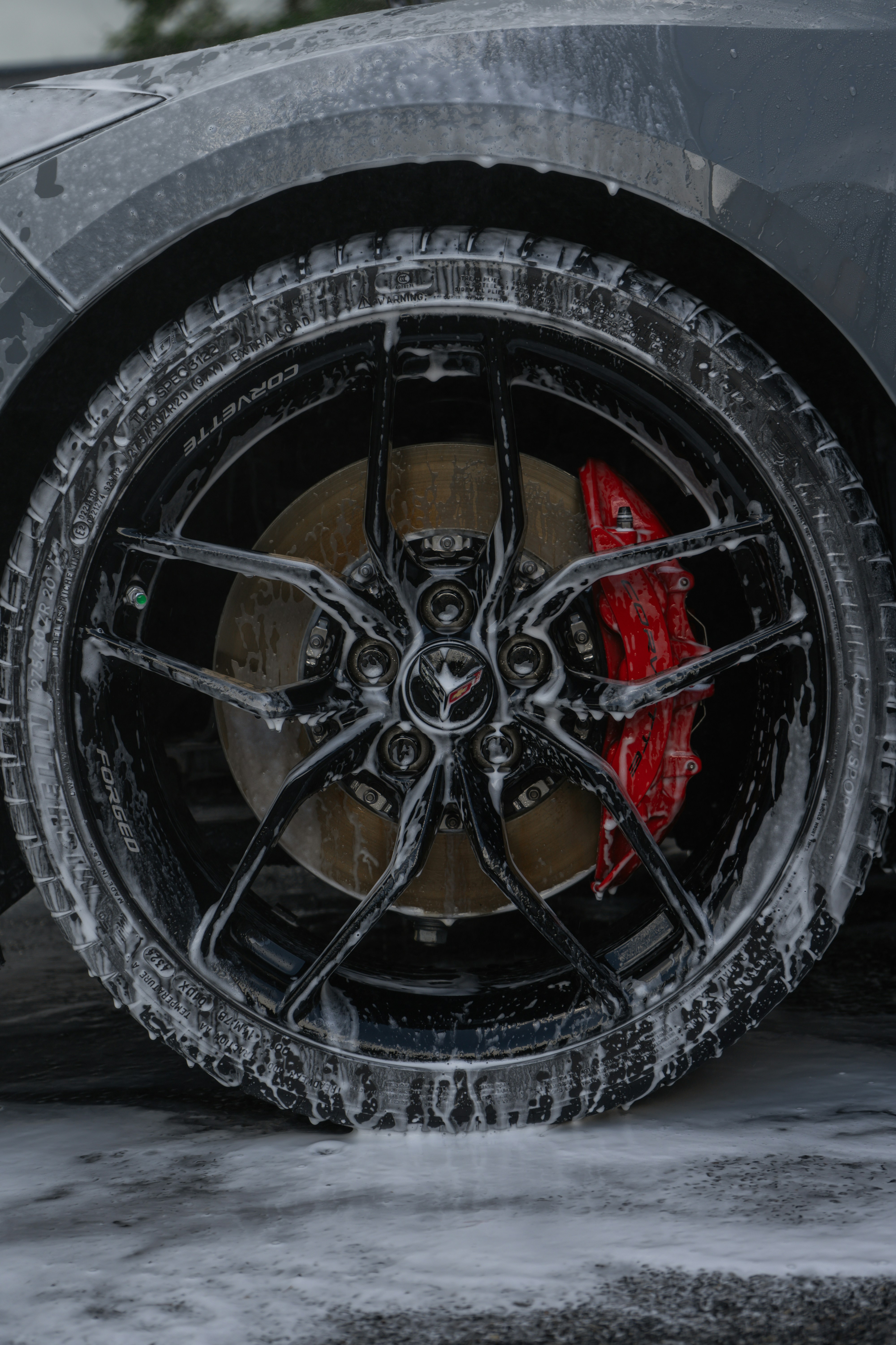A corvette wheel is being washed with soapy foam. photo – Free Car ...