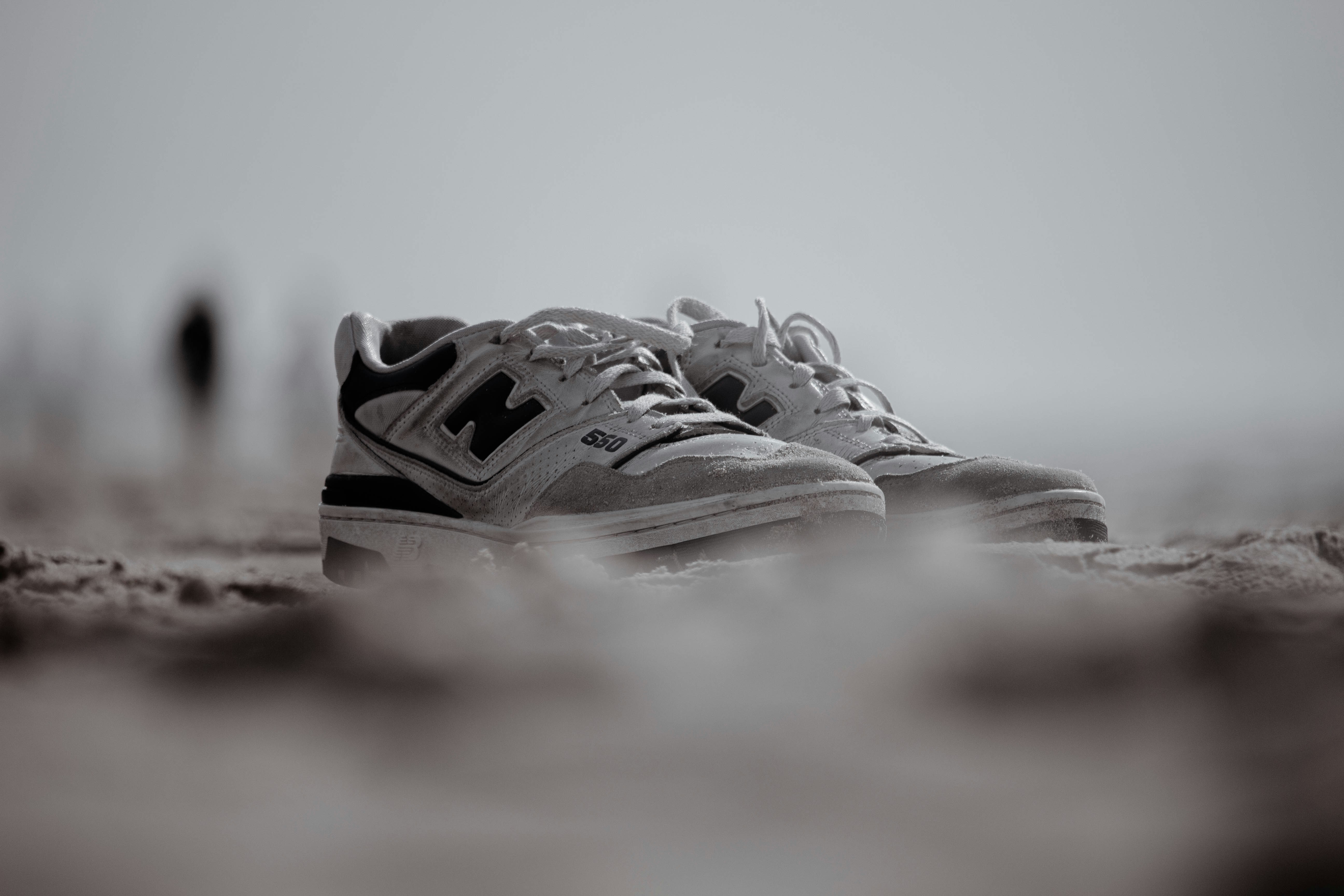 New balance sneakers rest on the beach. photo – Free Grass Image on ...