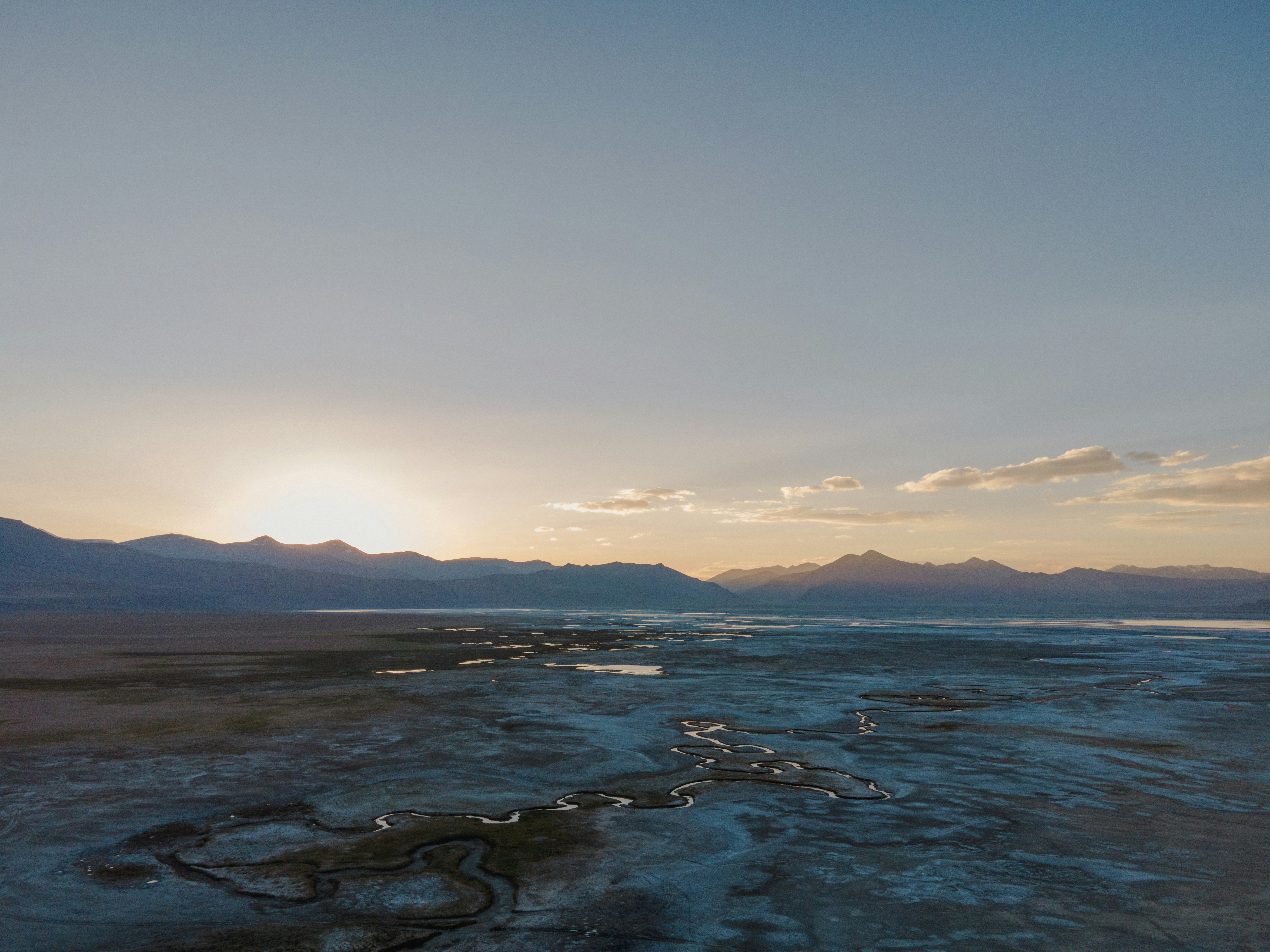 Sunset over a landscape with mountains and water. photo – Free Scenery ...