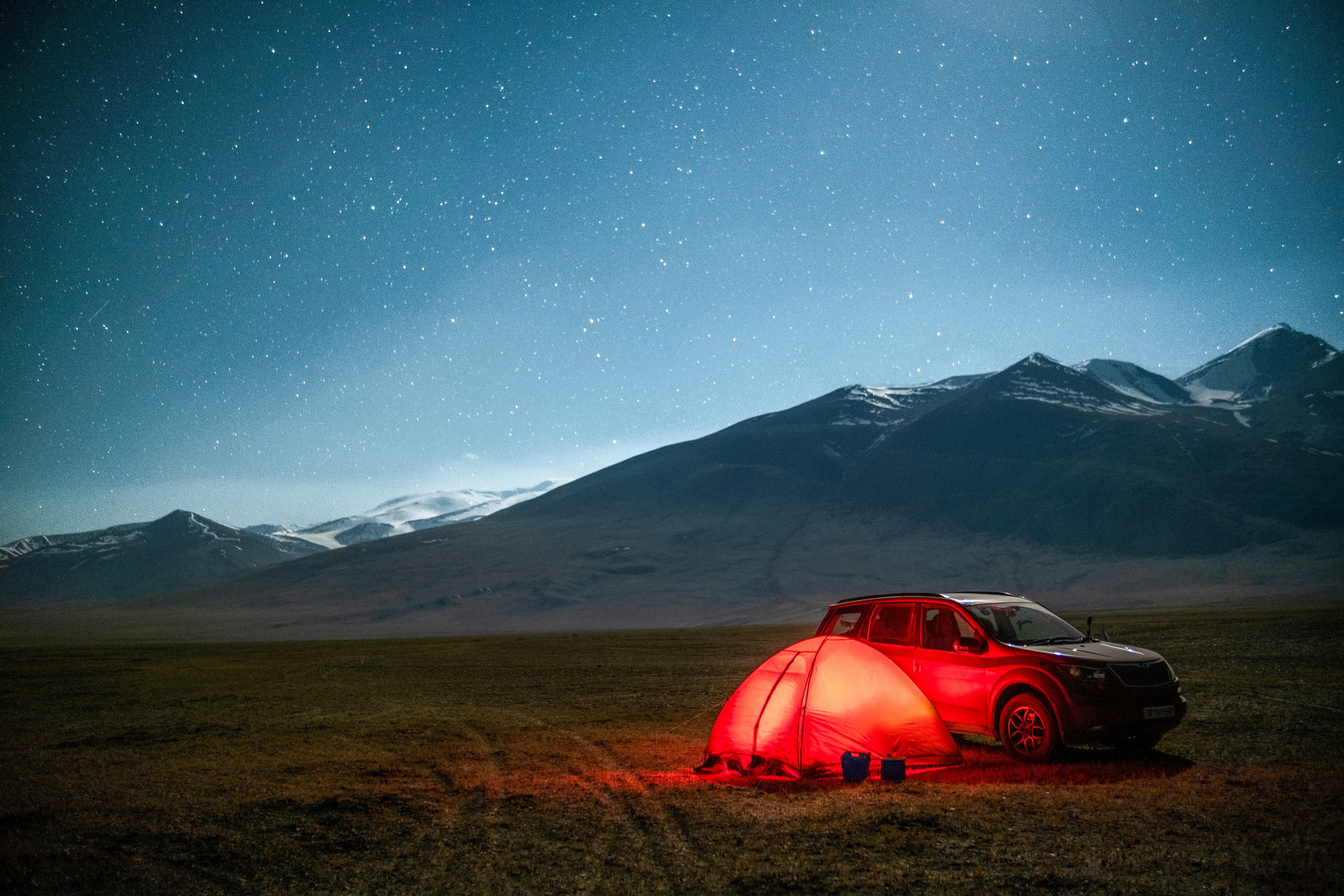 Camping under the stars, a car and tent.