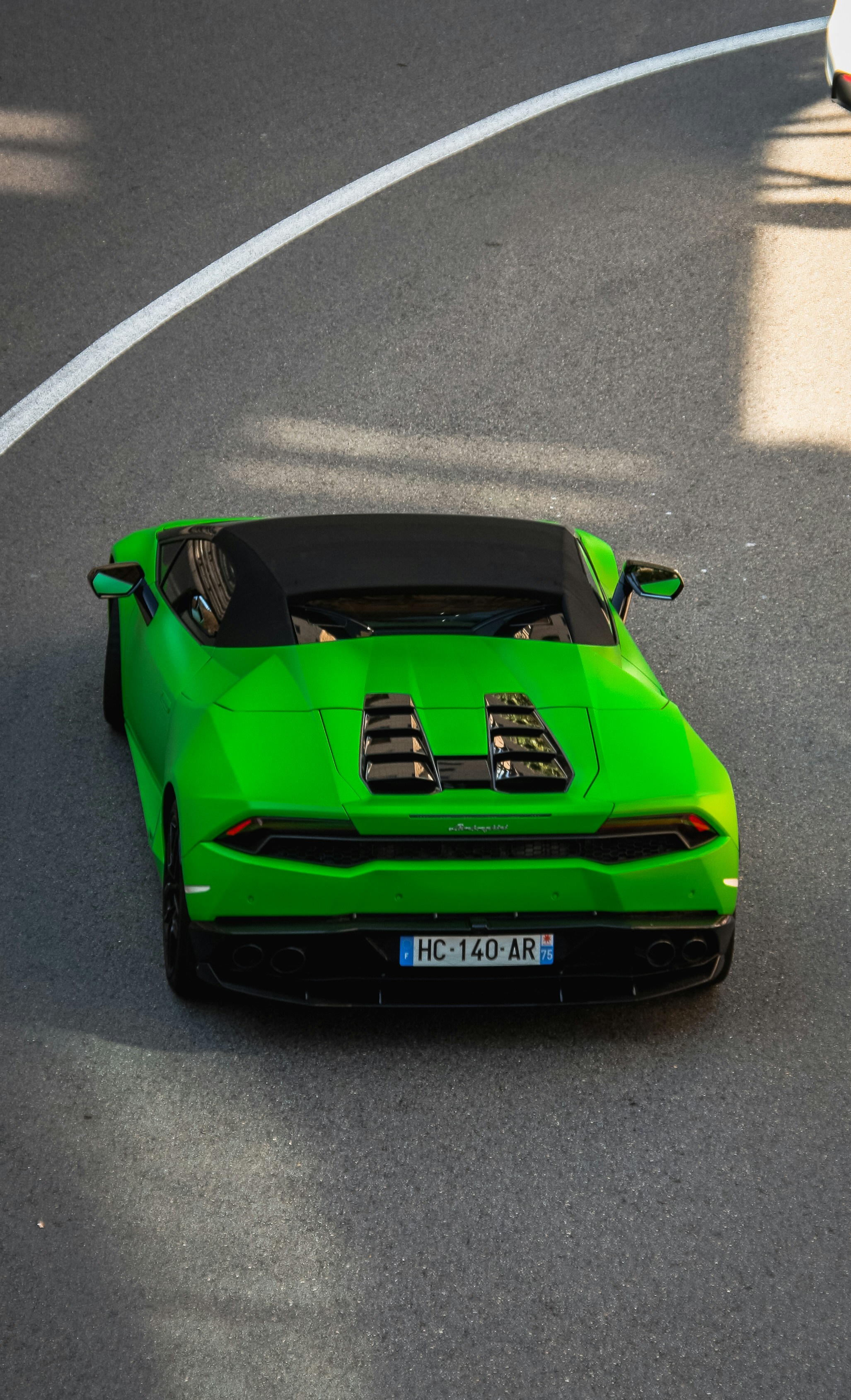 Emerald Hypercar Arc: Top-Down View of a Neon-Green Beast on a Winding Road