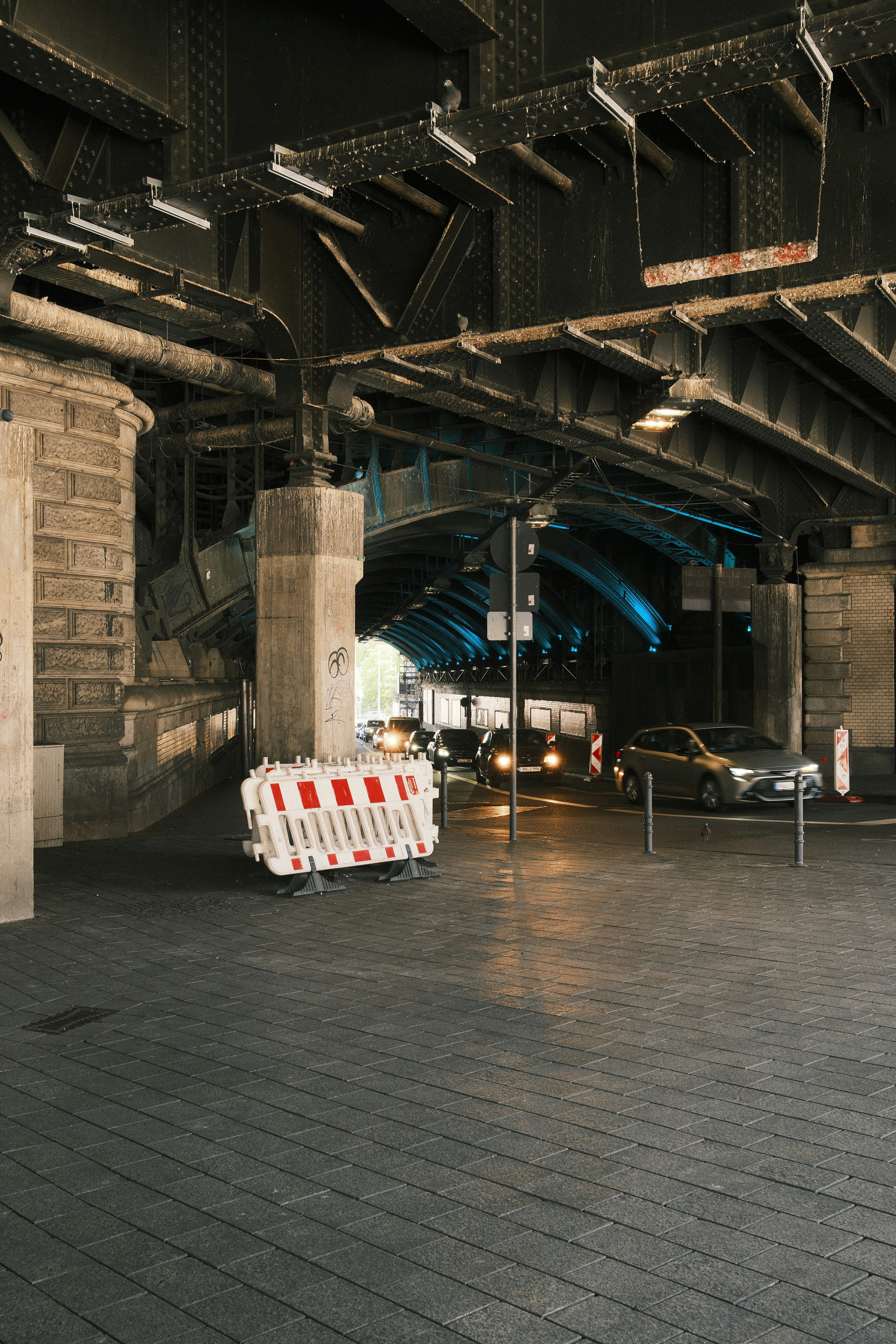 Blue Arches and Headlights: Night Drive Beneath a Steel Bridge