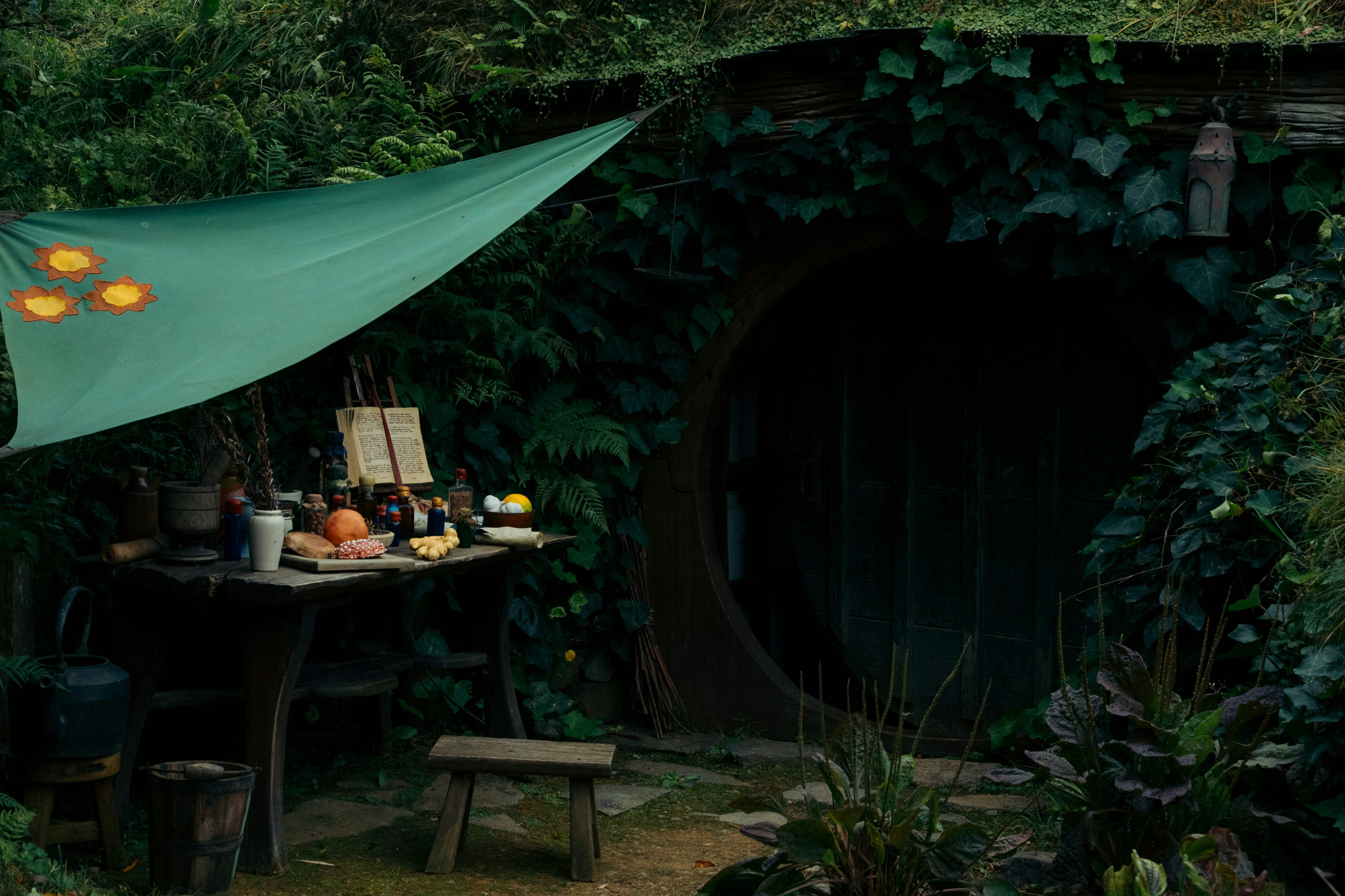 A hobbit-hole entrance with supplies under a canopy. photo – Free ...
