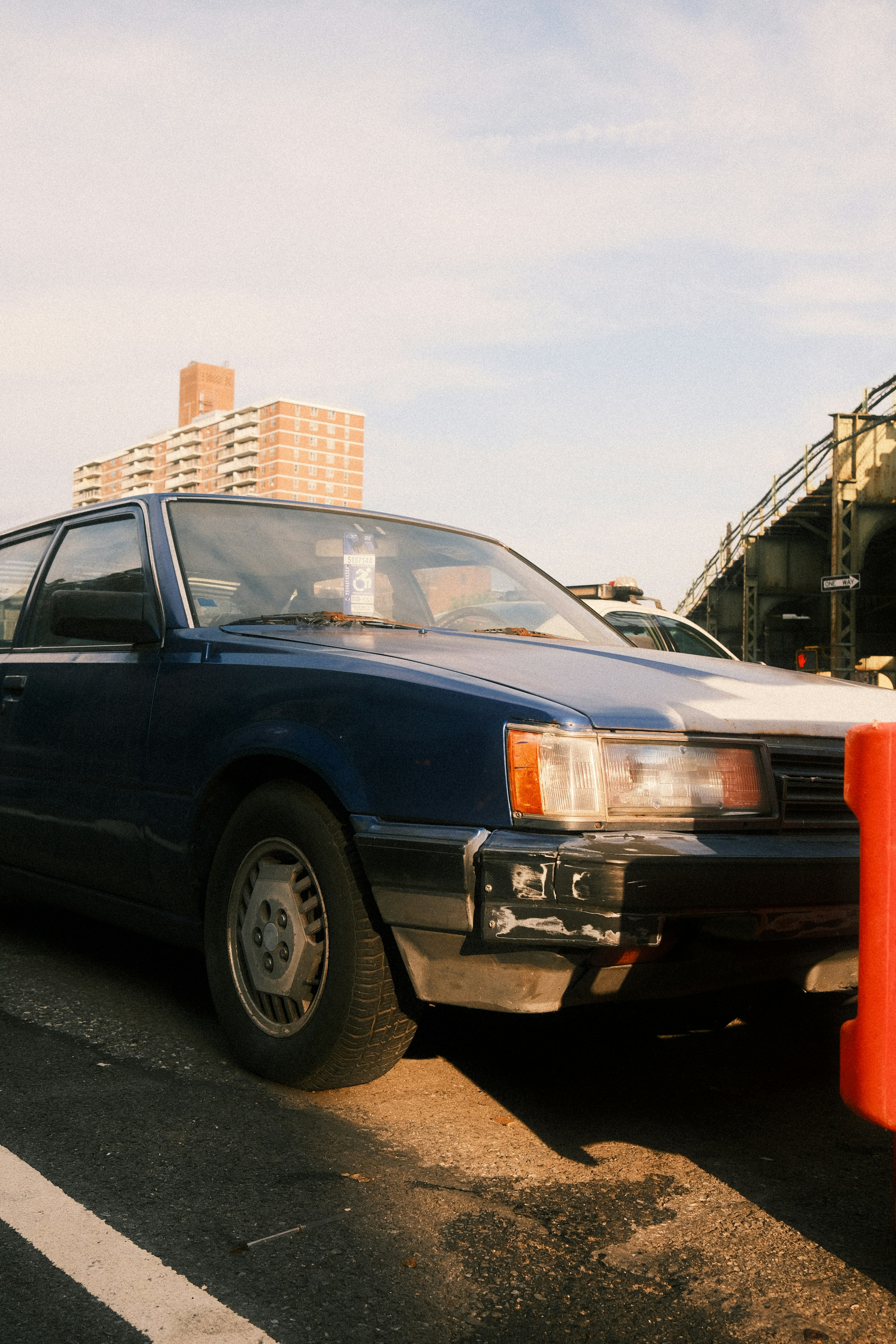 A blue vintage car parked on the street.