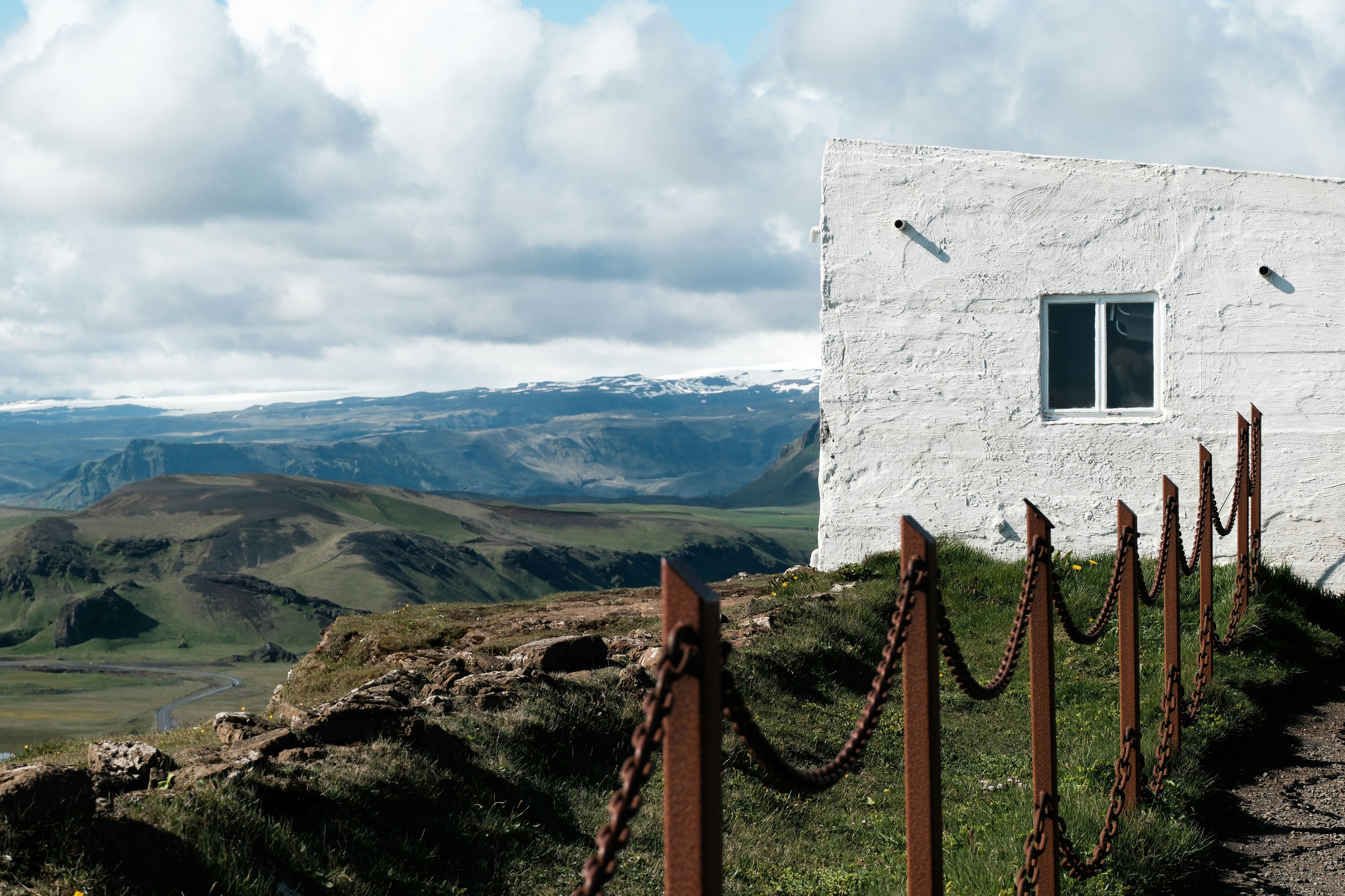 Cliffside White Outpost: A Quiet Beacon Over Rolling Valleys