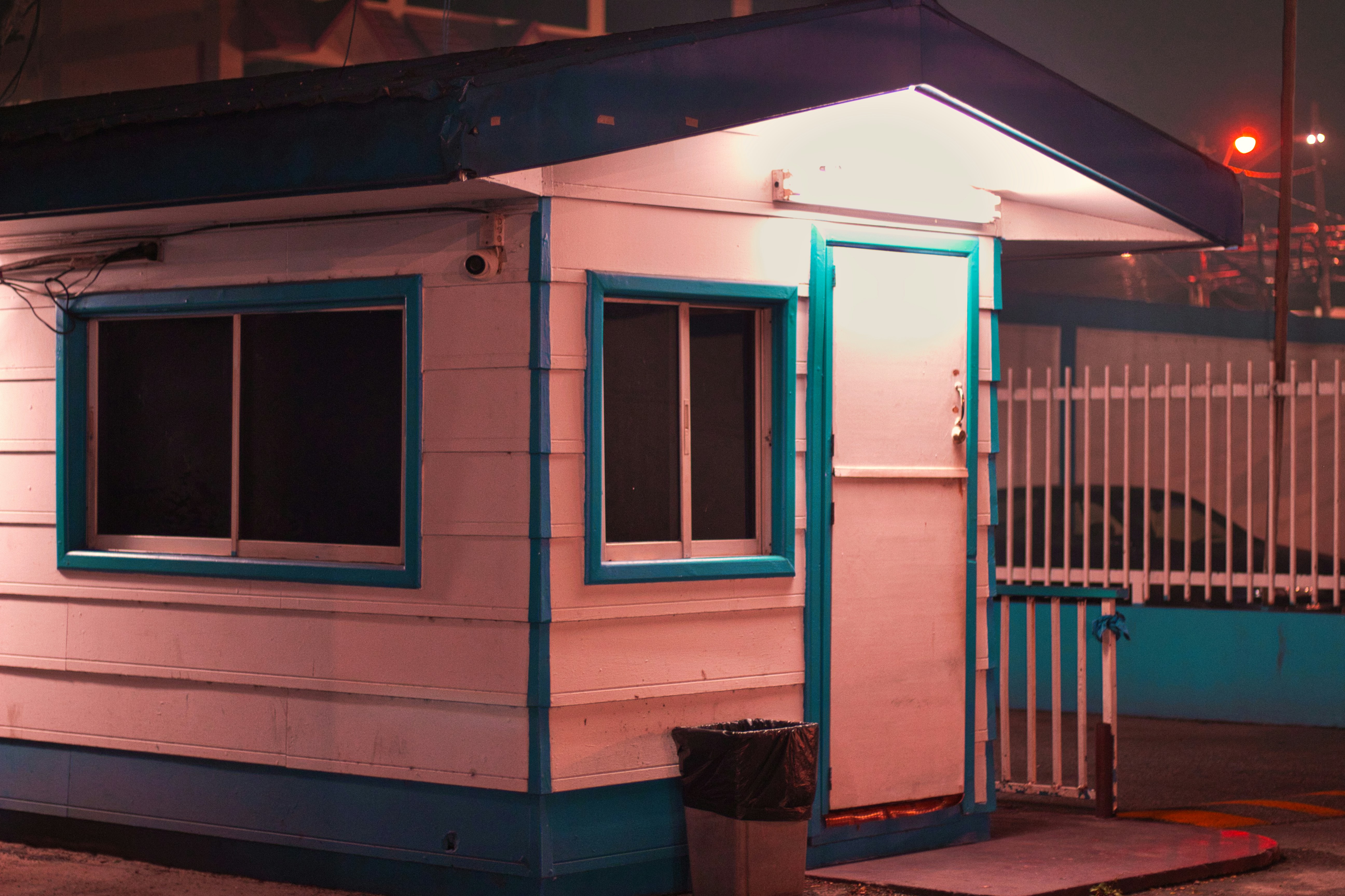 A security guard house stands guard at night.