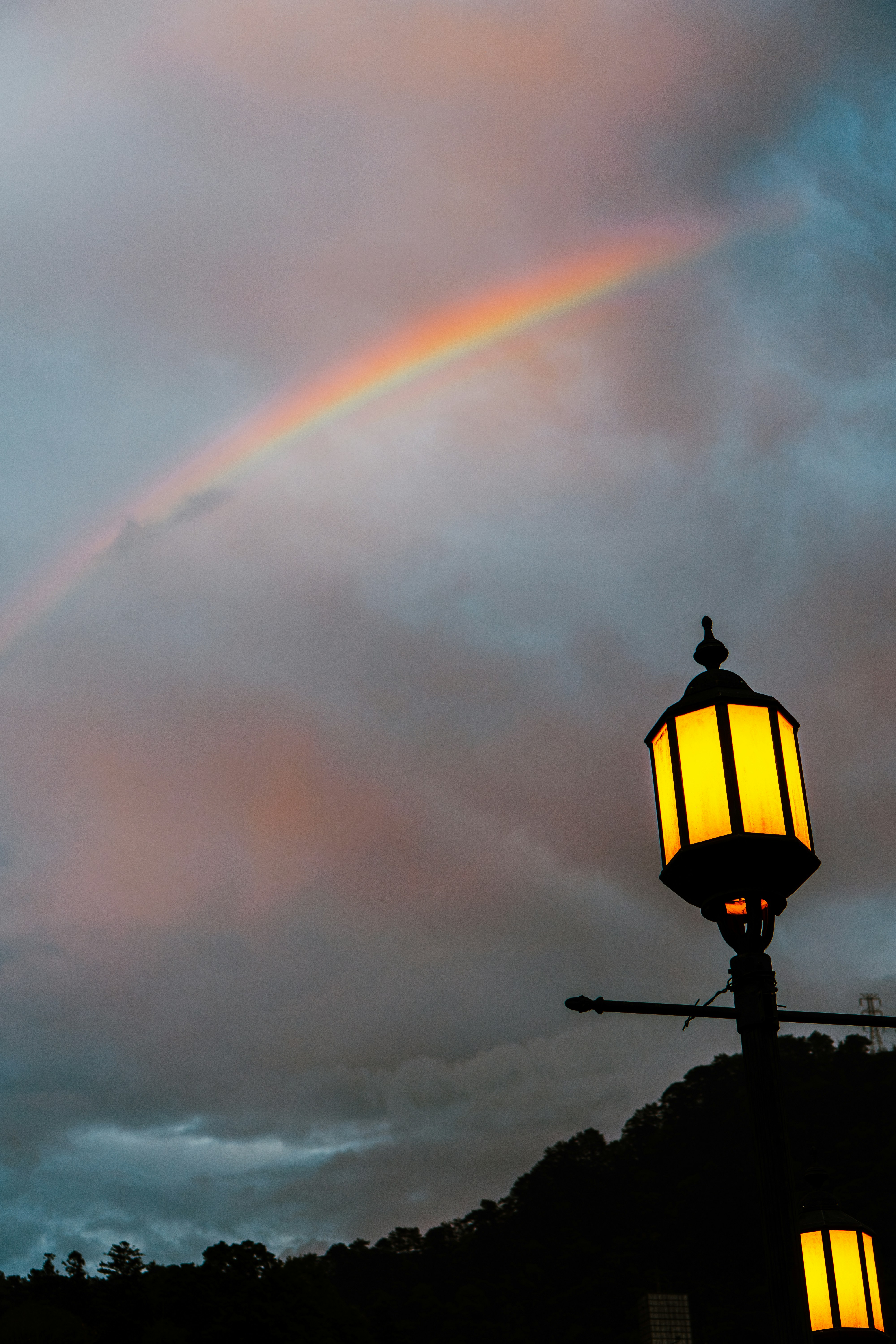 Illuminated Dreams: A Lantern Beneath the Arc of Color