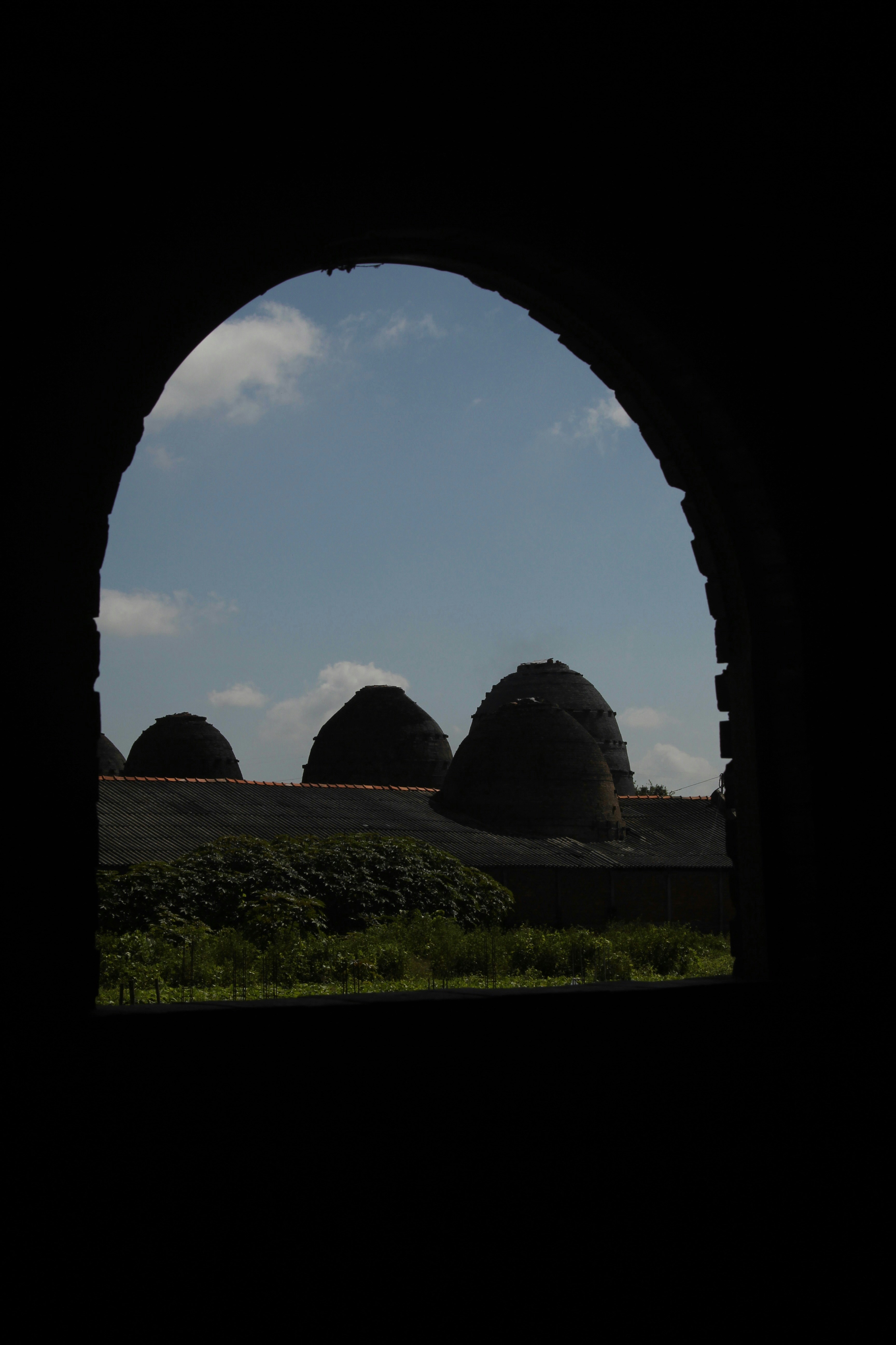 Framed Beehive Domes: A Quiet Horizon through a Shadowed Arch