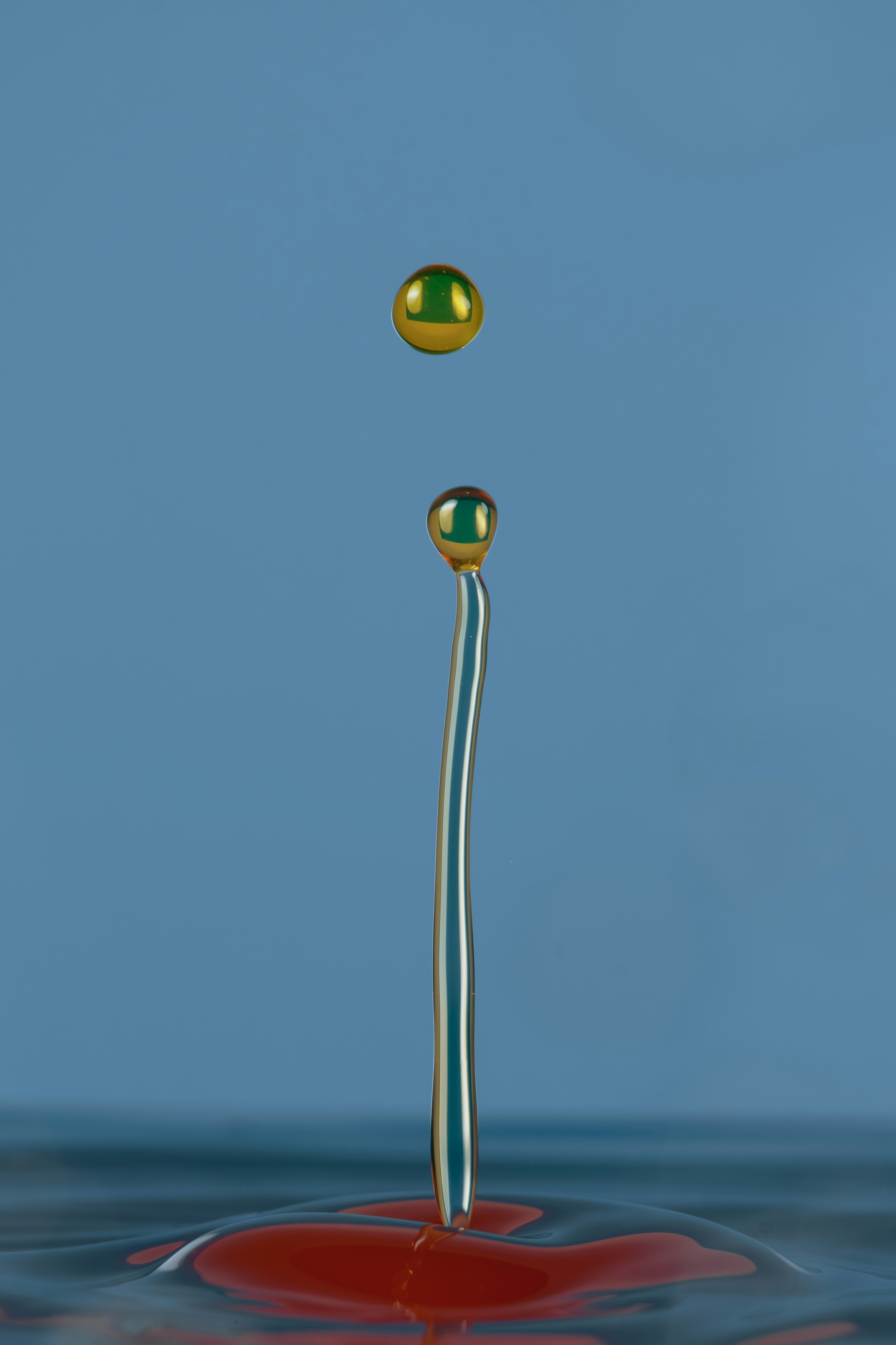 A colorful water droplet forms a unique shape.