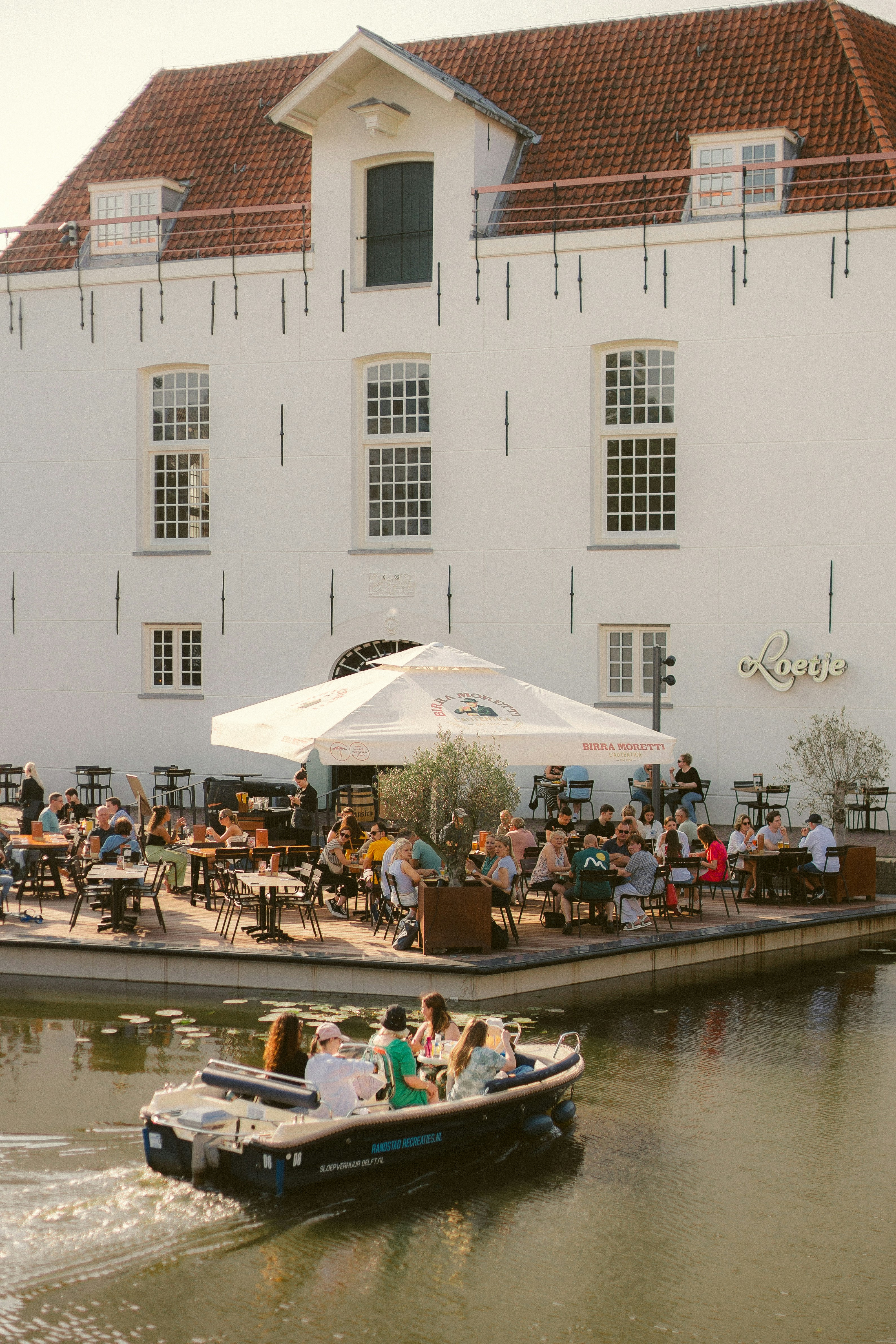 Waterfront Café Under a White Facade