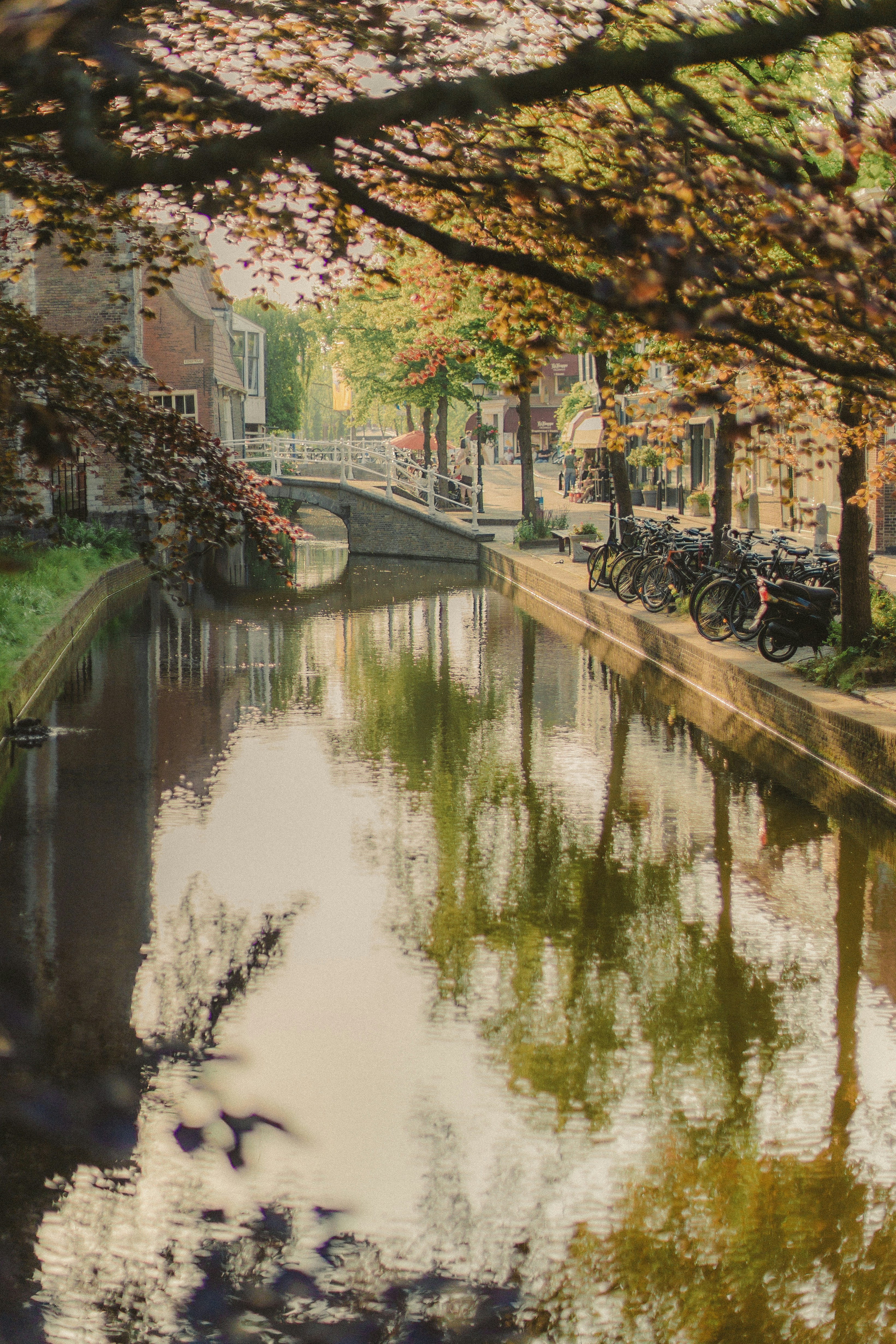 A canal in the city with bridges and bikes.