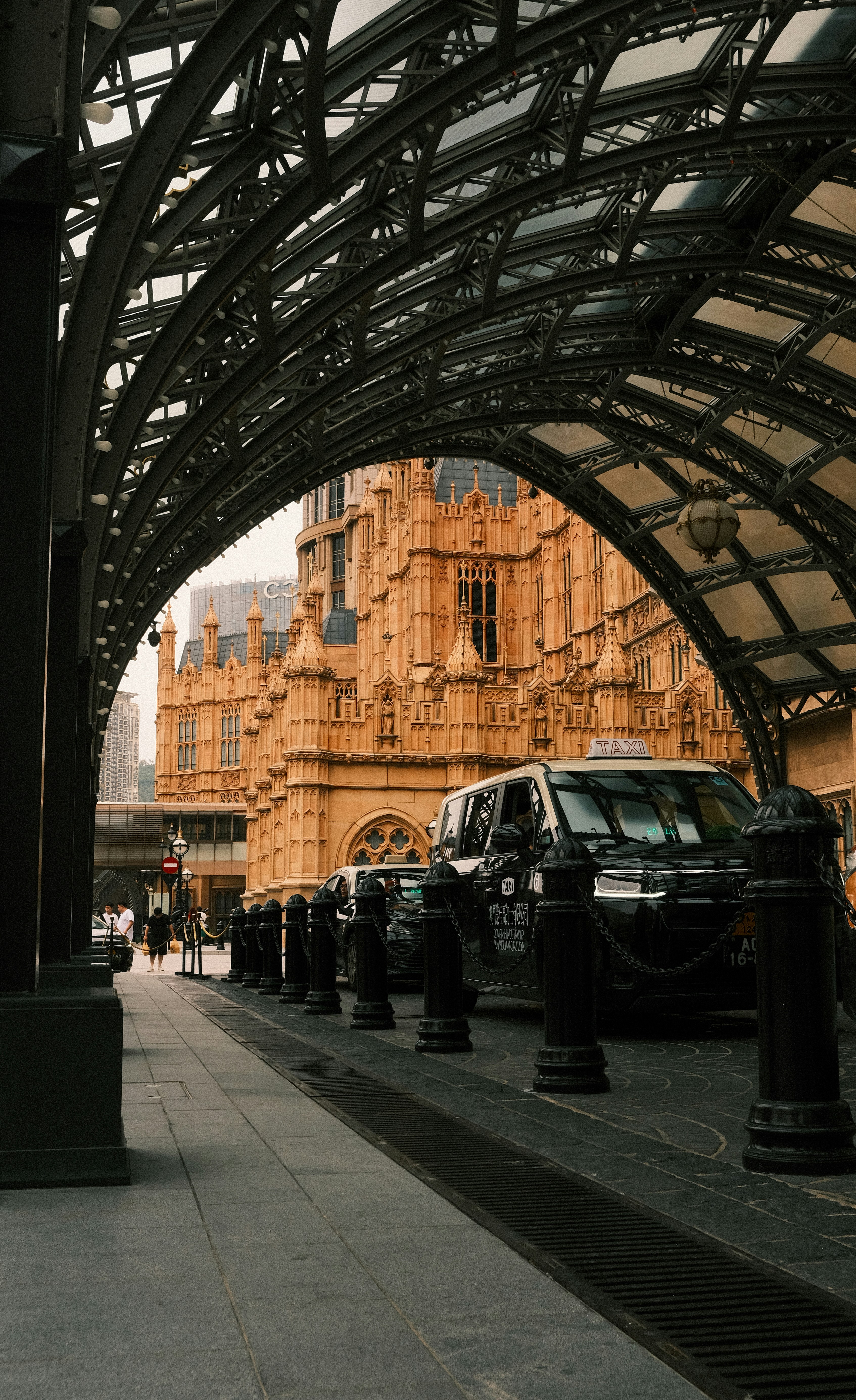 A taxi waits in front of a historic building.