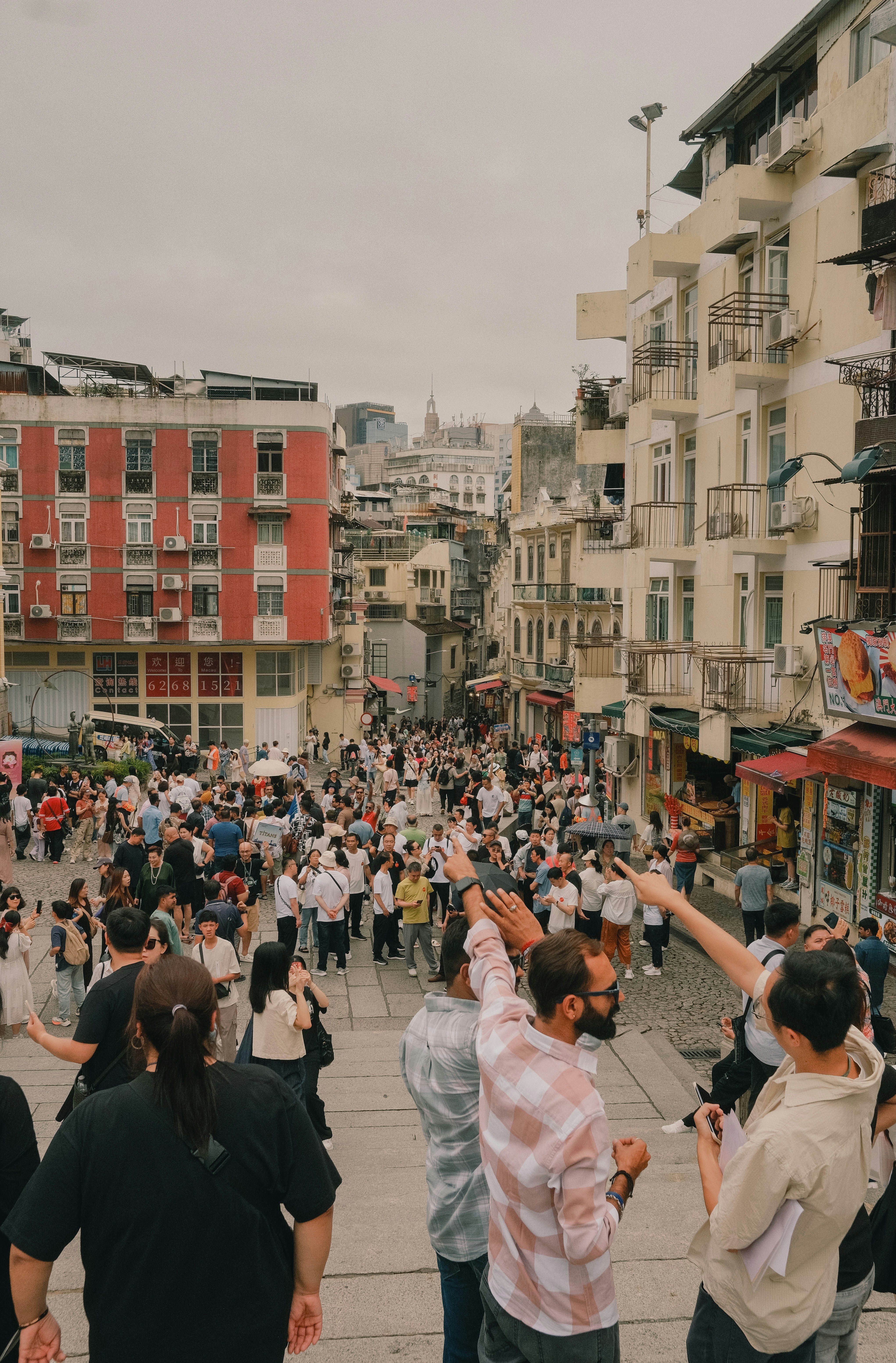 Rising Hands on a Sunlit Slope: A City Street Rally