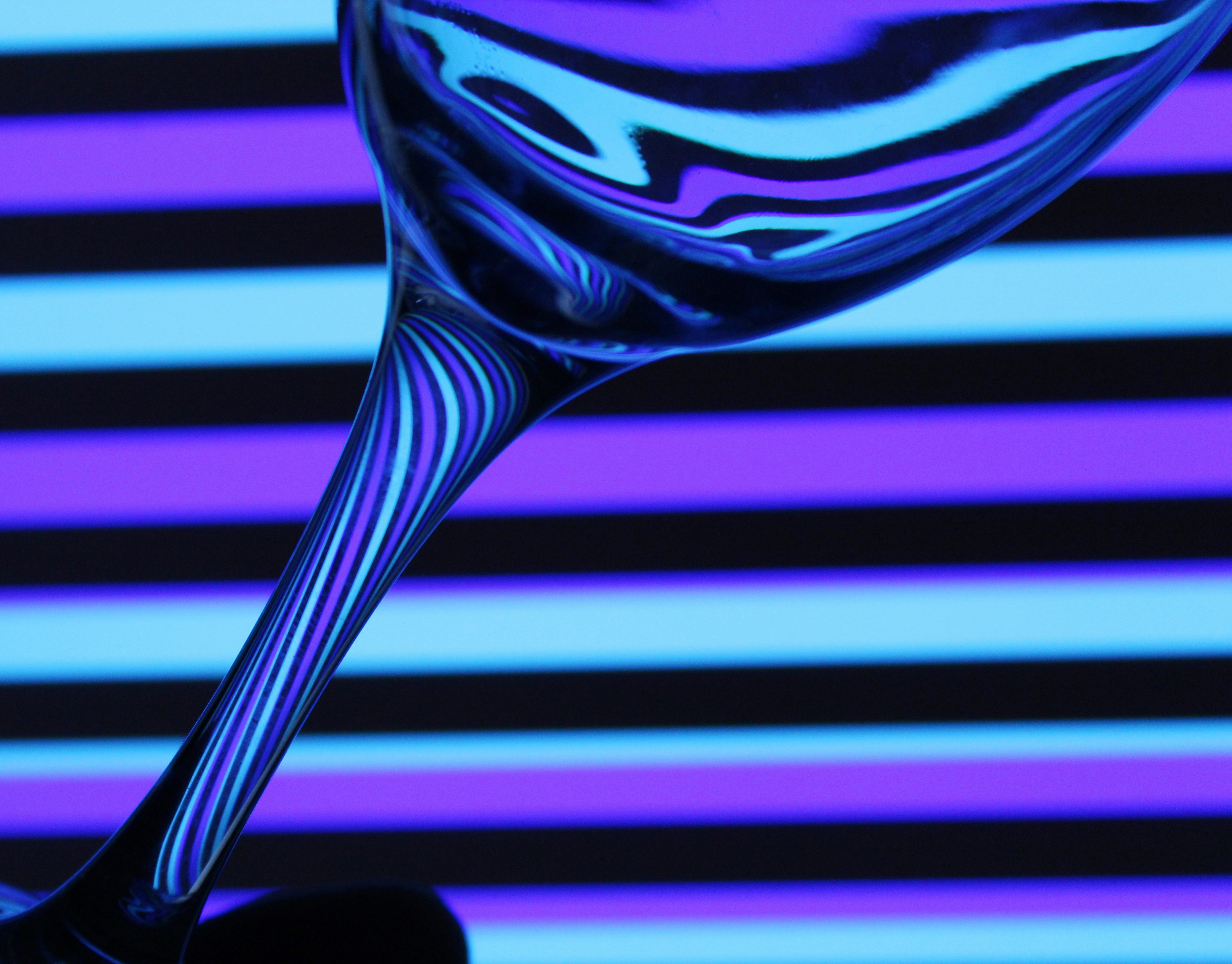 Neon Refractions: Glass Stem Dancing with Striped Light