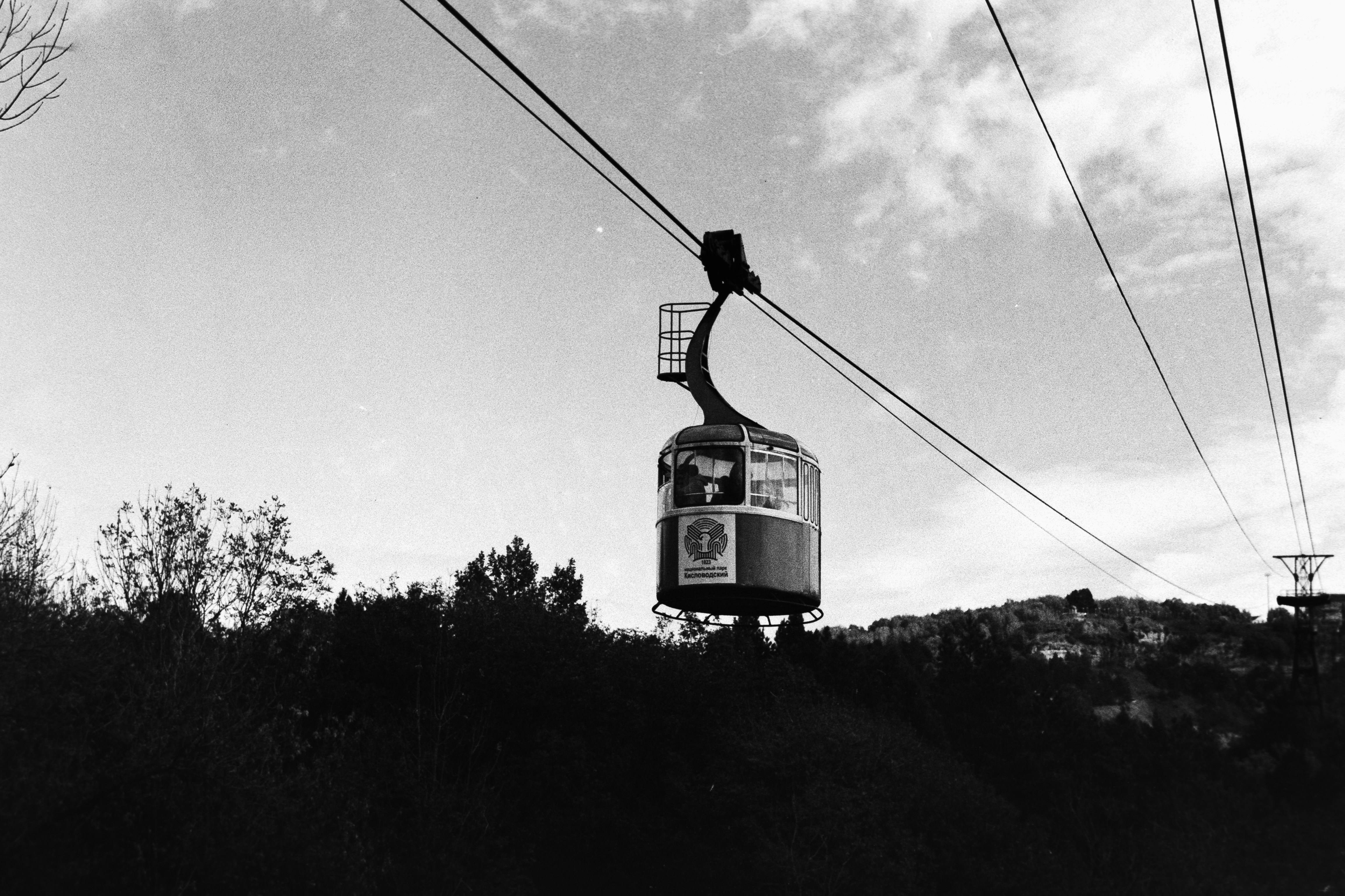 Cable Car Over a Quiet Horizon: A Lone Transit in Monochrome