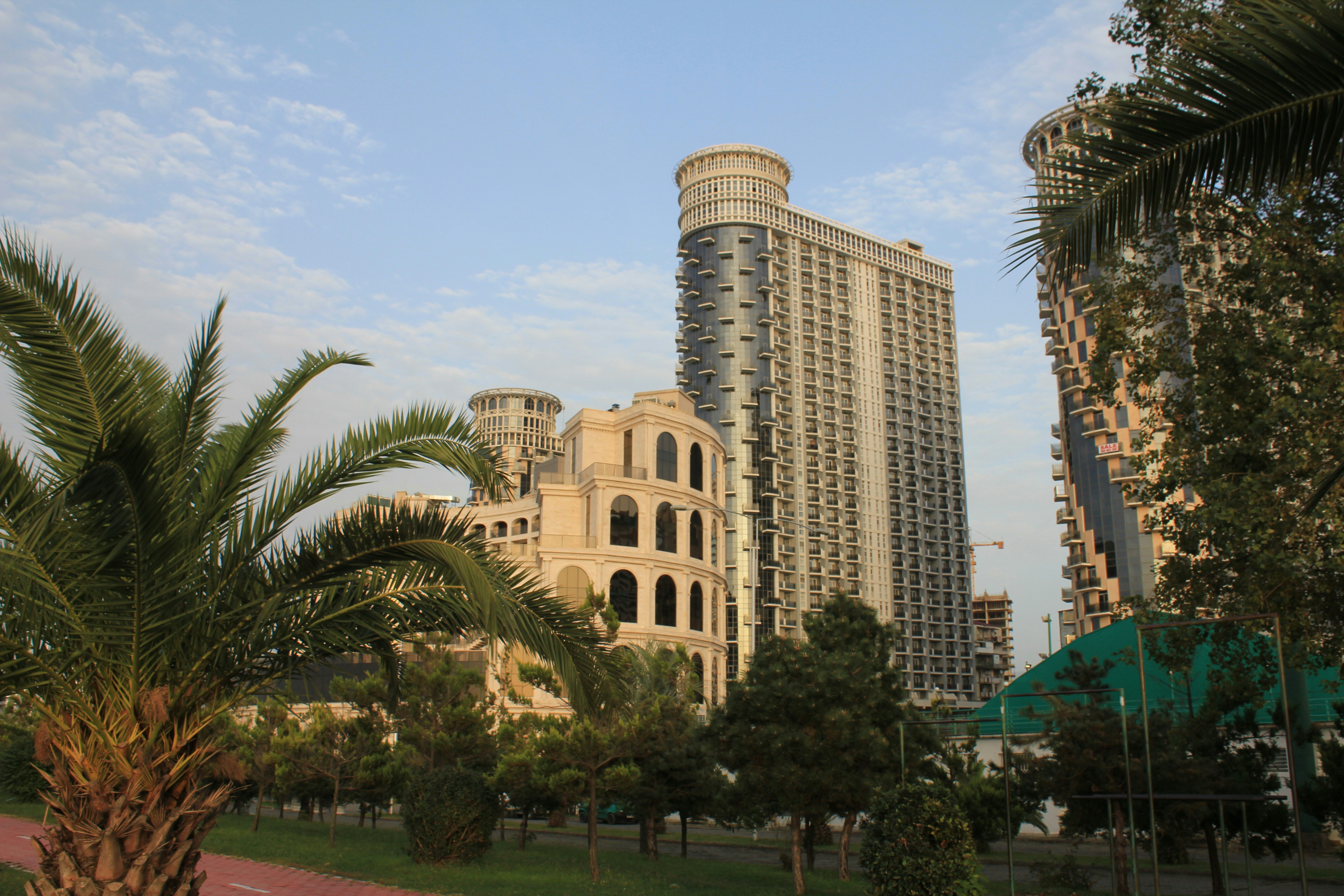 Modern buildings stand tall under a blue sky.