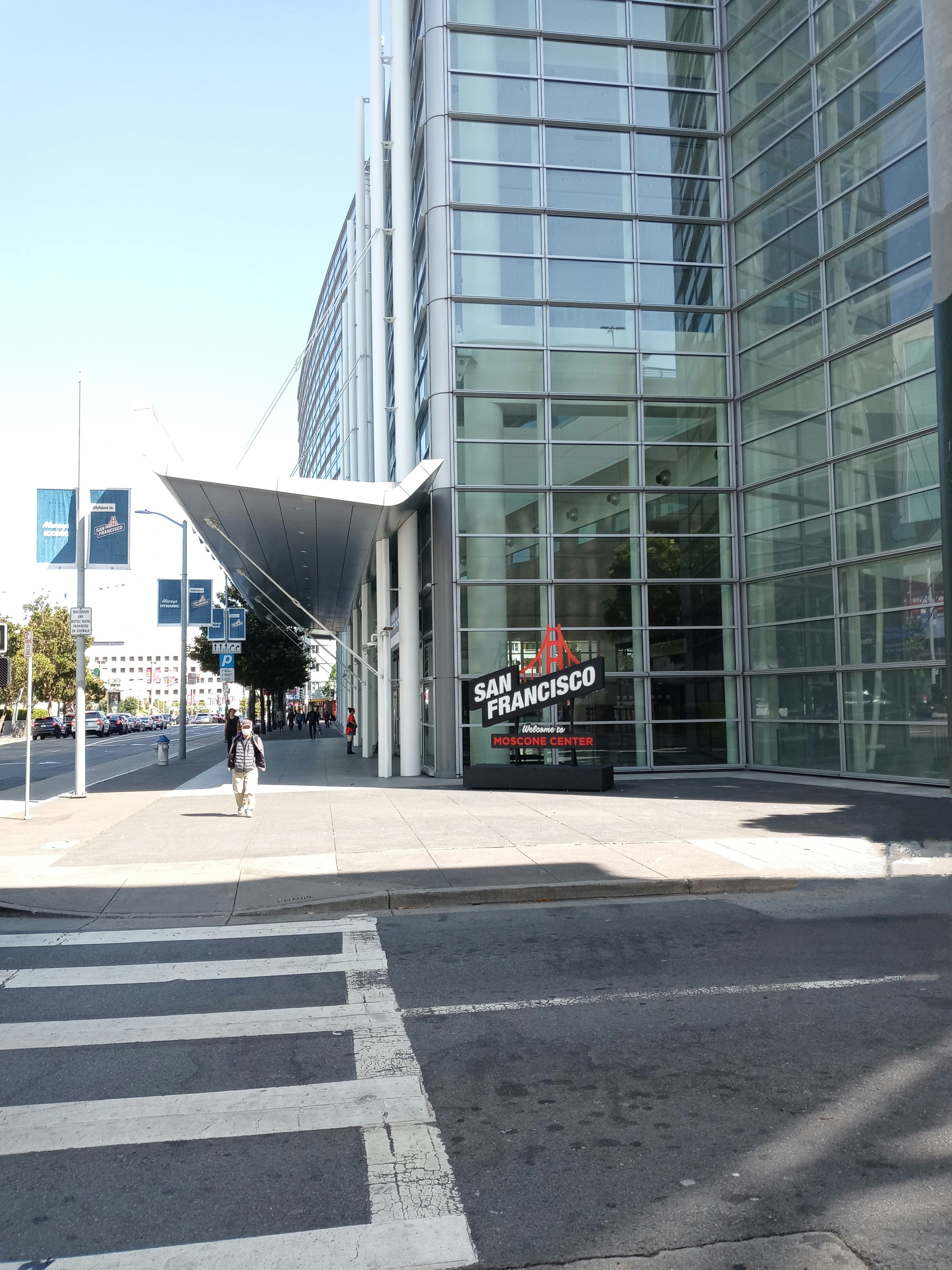 Modern glass building with a prominent sign reading 'SAN FRANCISCO' at its entrance, showcasing urban design and city atmosphere.