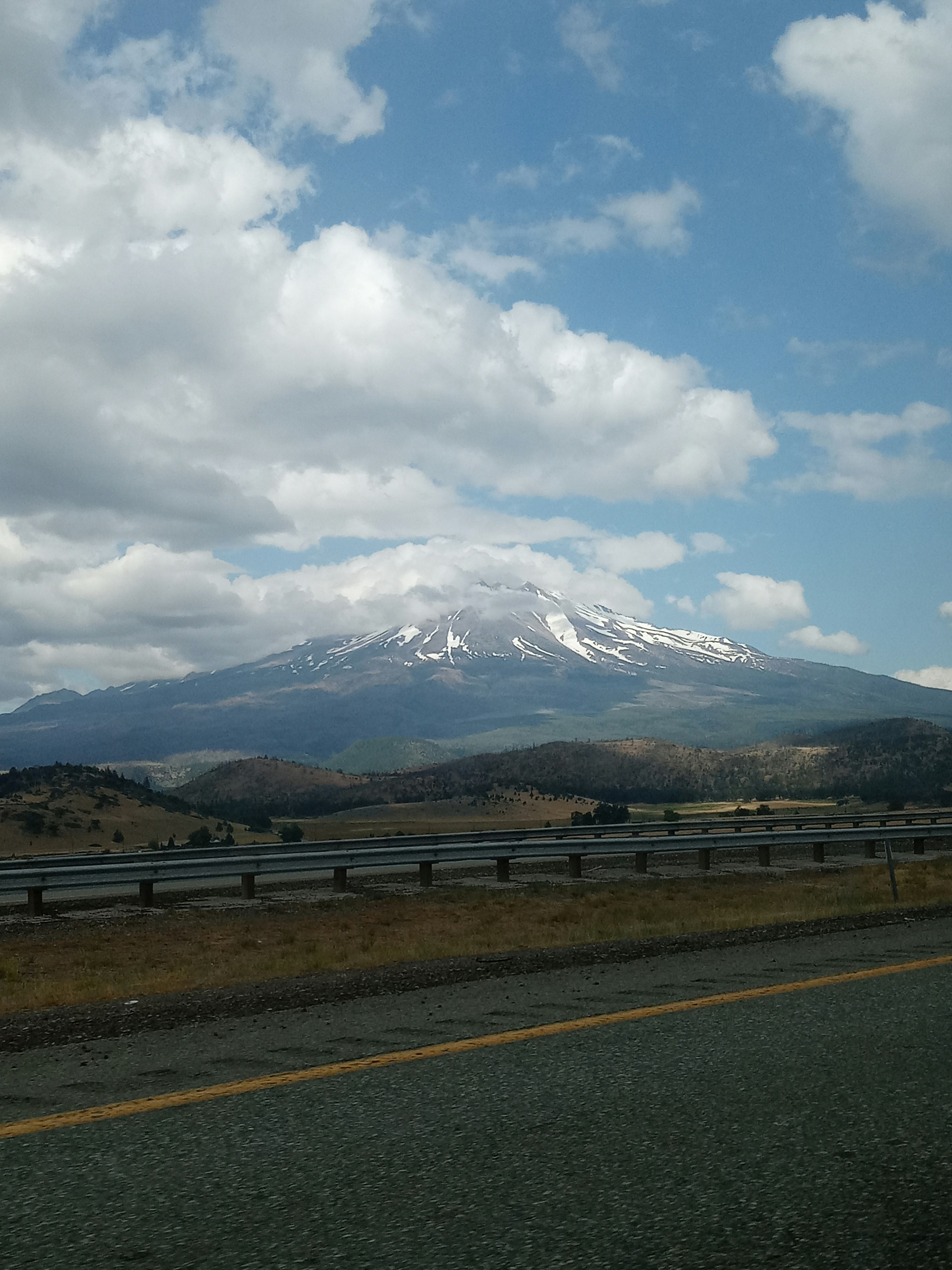 Mt. Shasta | A snowy mountain stands under a cloudy sky.