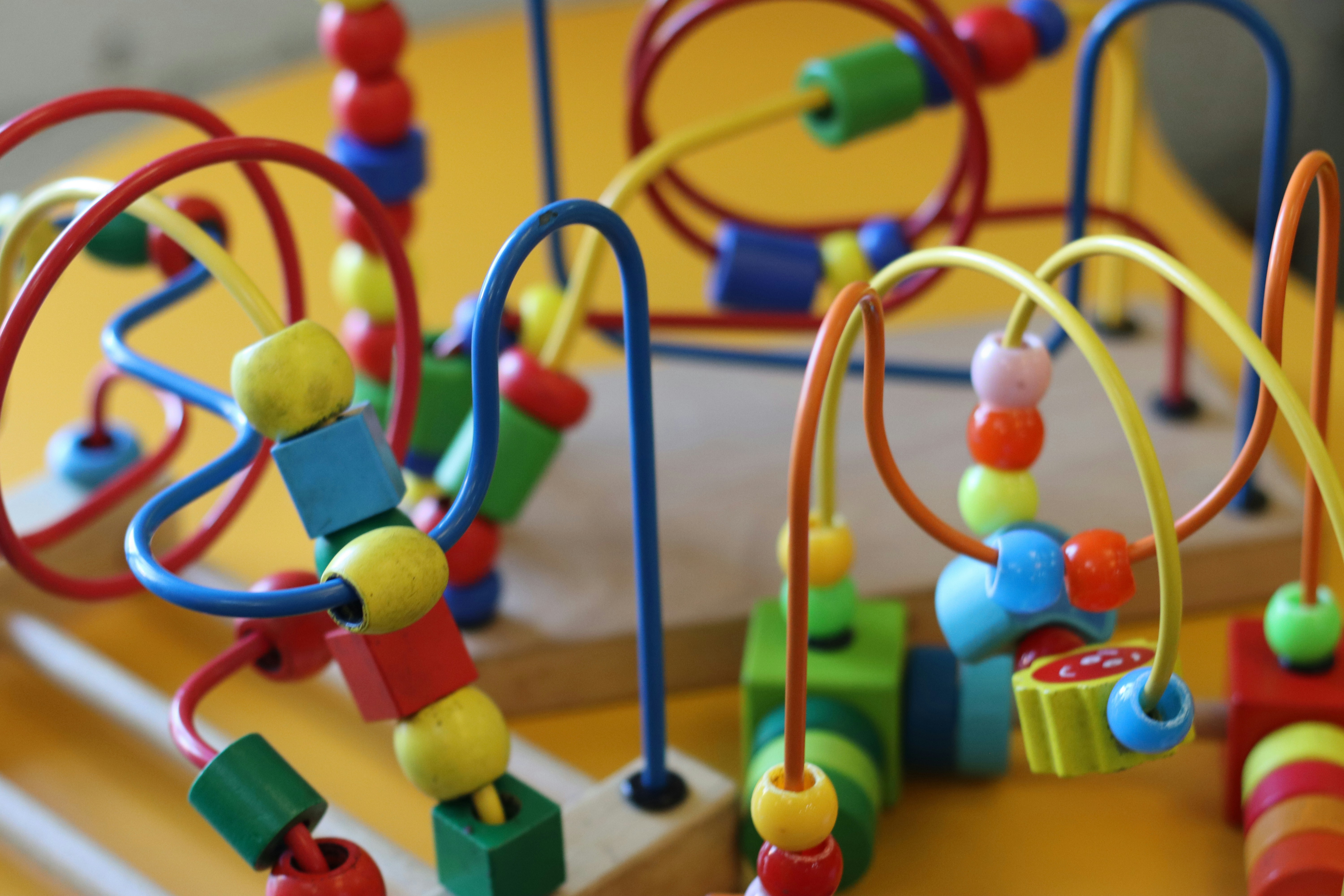A vibrant arrangement of a children's bead maze showcasing various shapes and colors, designed to stimulate creativity and fine motor skills.