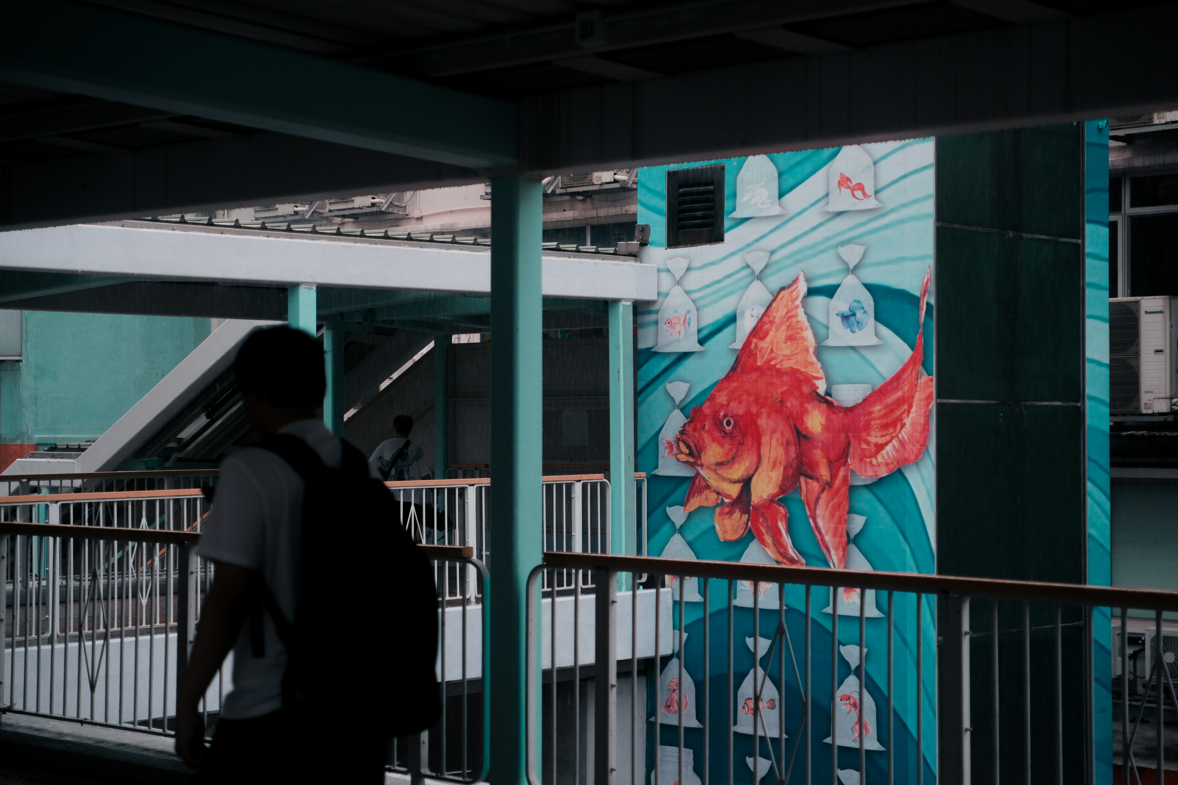 A person walks past a colorful mural.