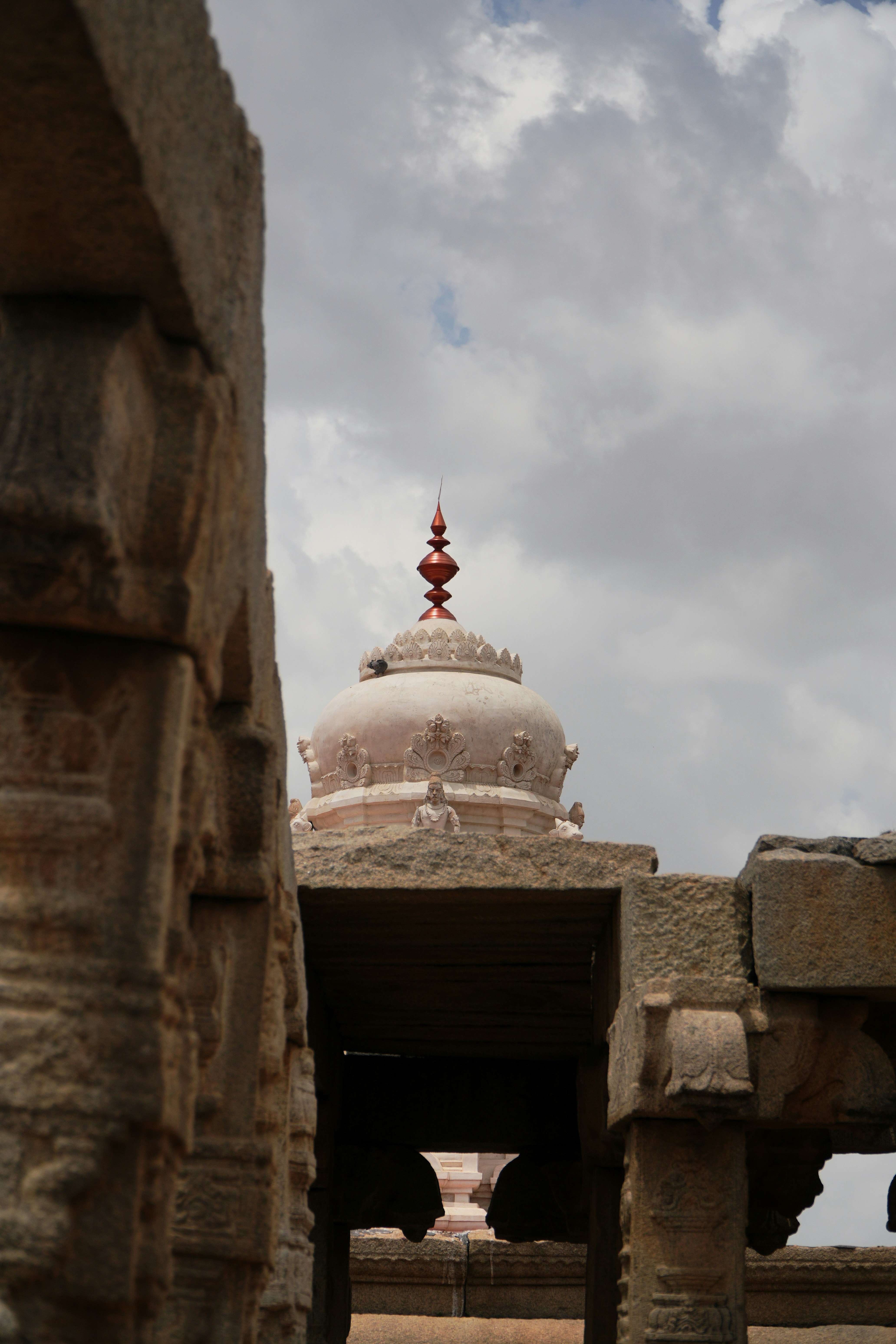 A temple dome peeks from ancient architecture.