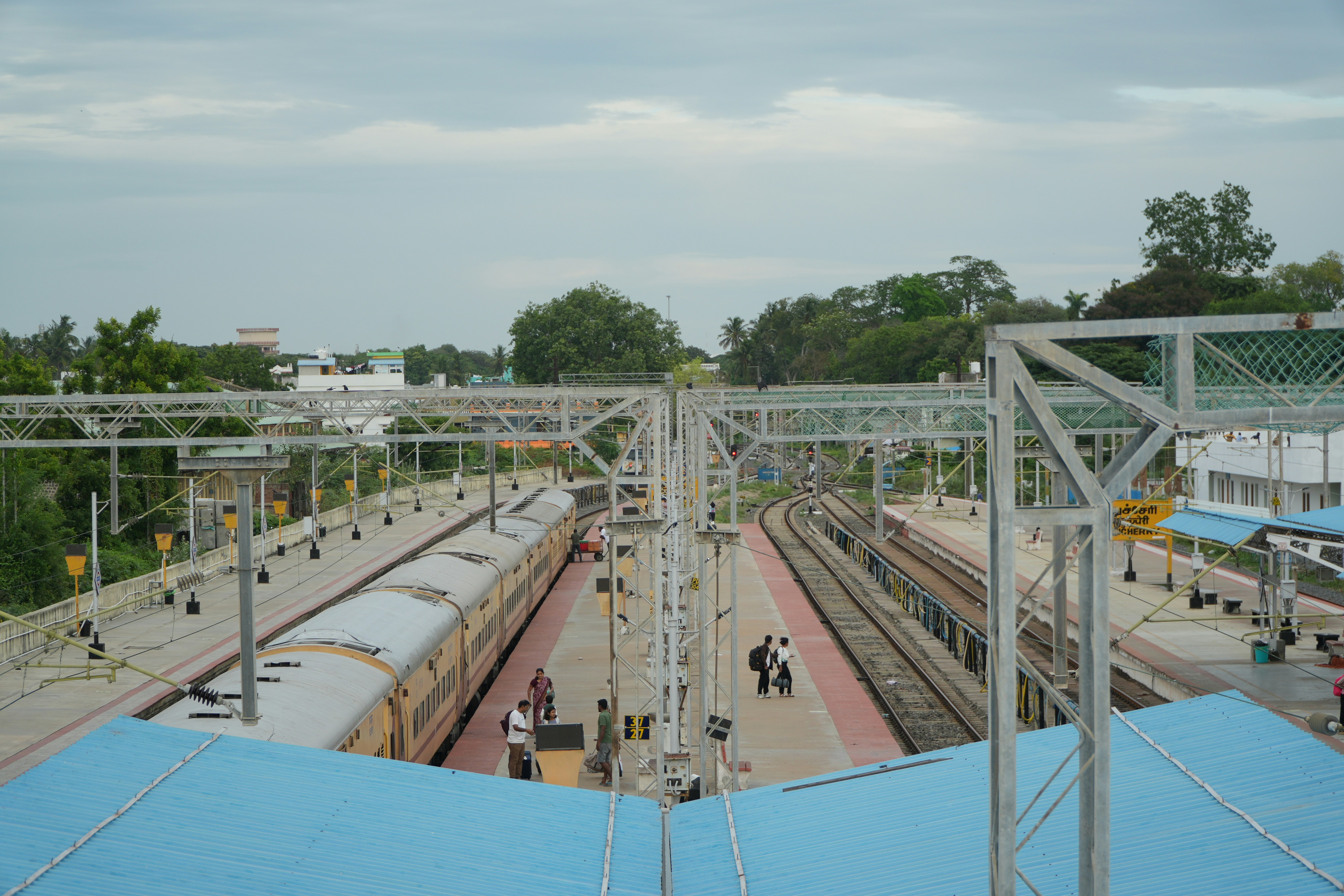 A train station with tracks and trains. photo – Free Human Image on ...