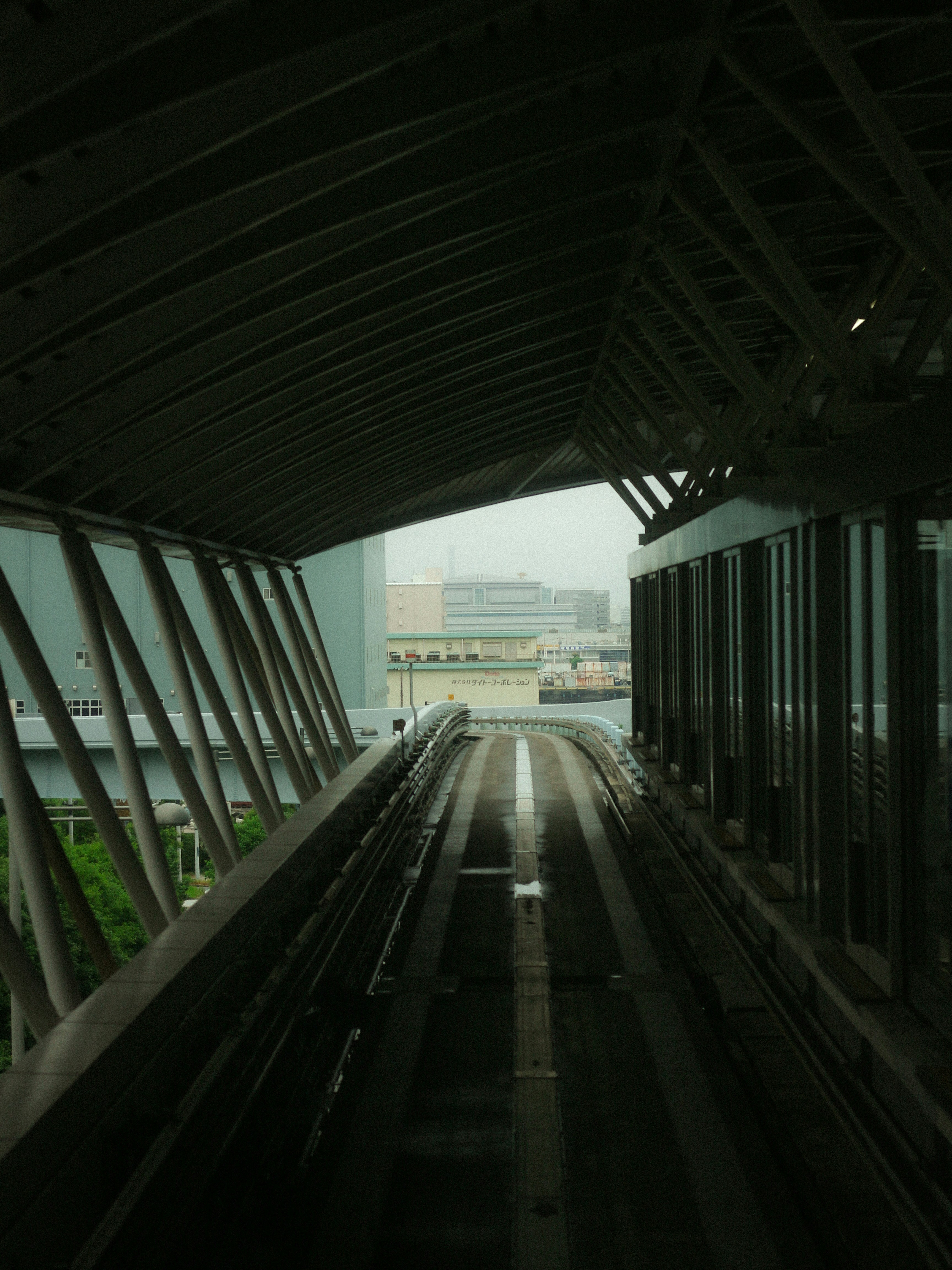 A covered train track stretches into the distance. photo – Free City ...