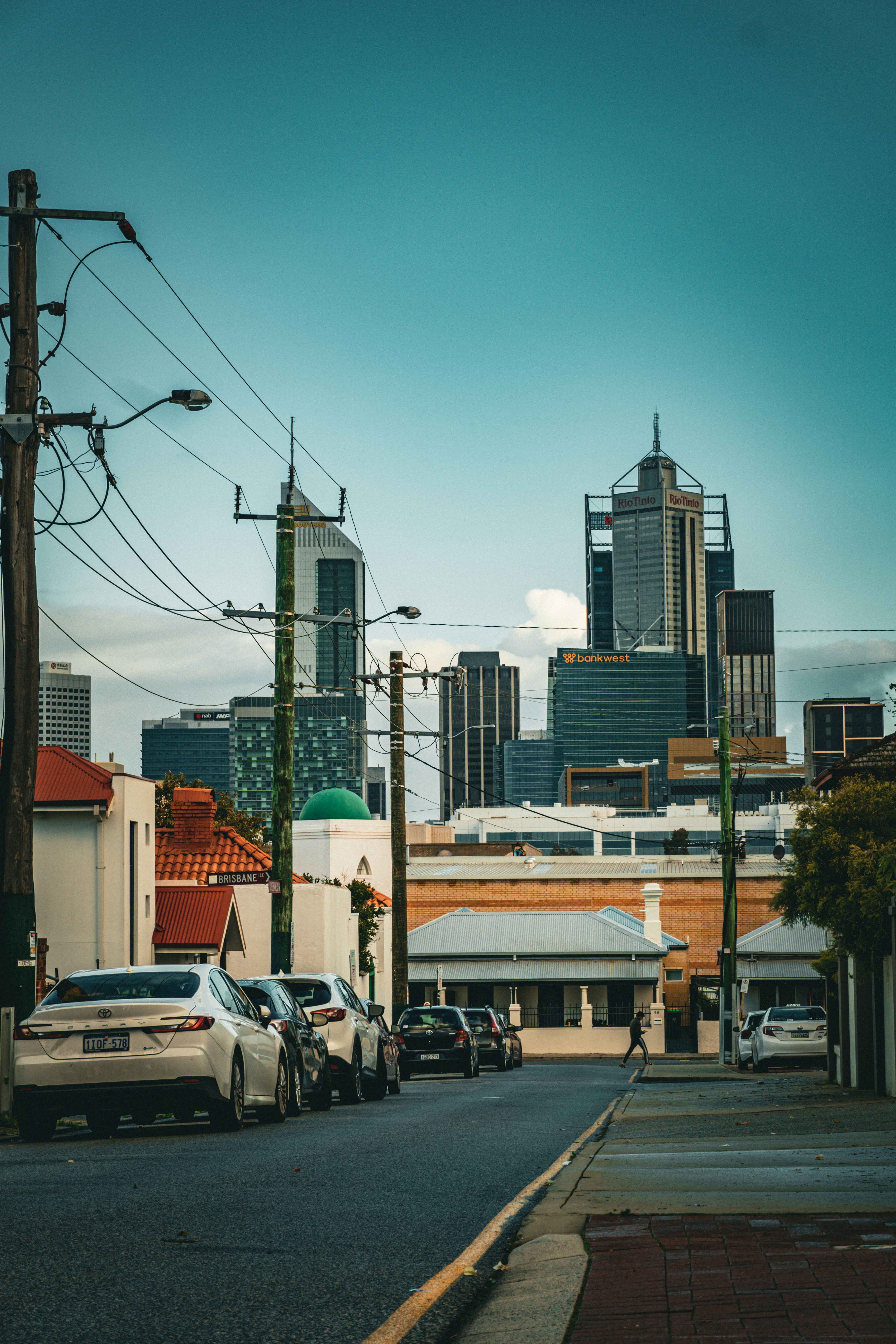 Cityscape view of buildings and cars on the street.