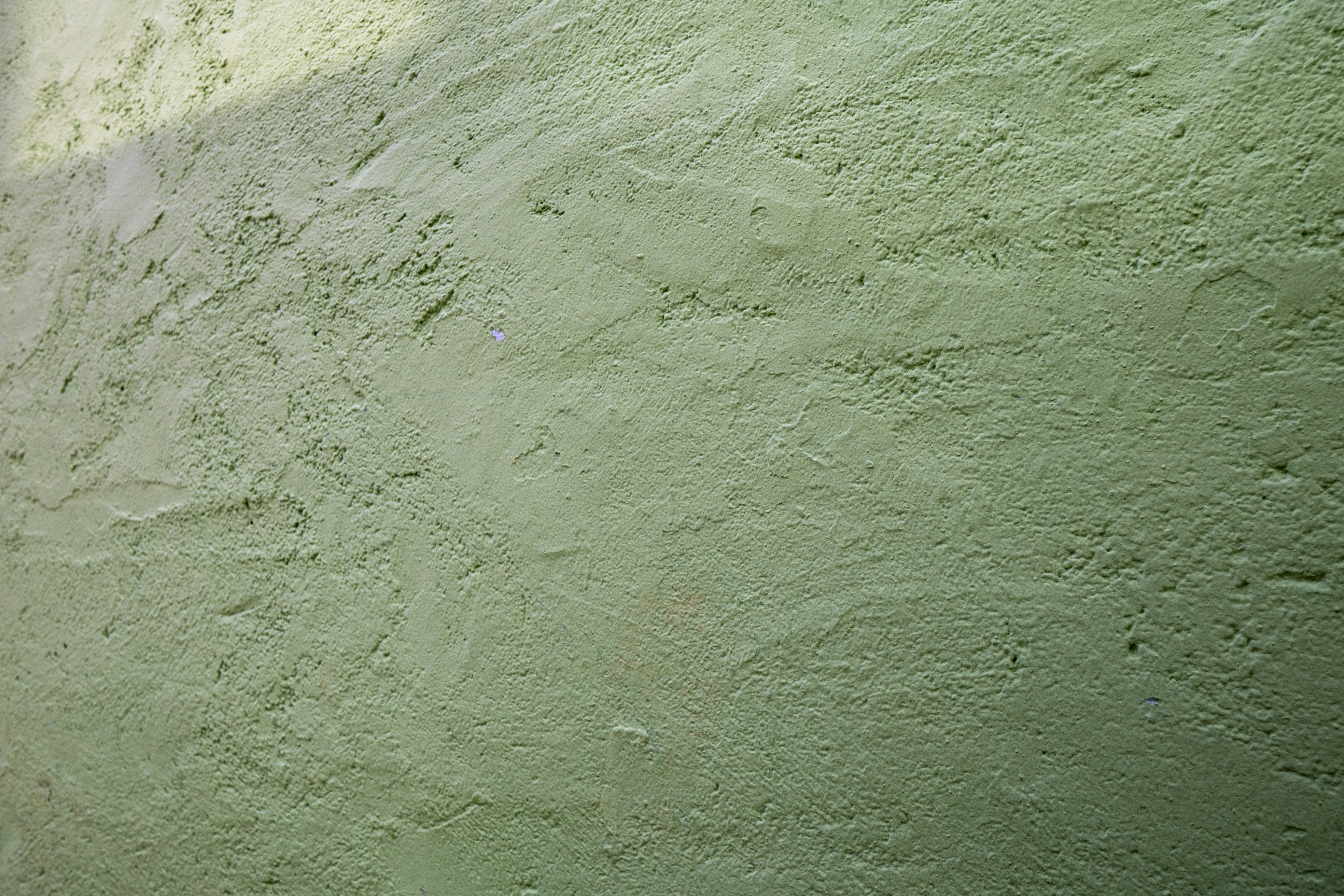 Textured, green painted wall.
