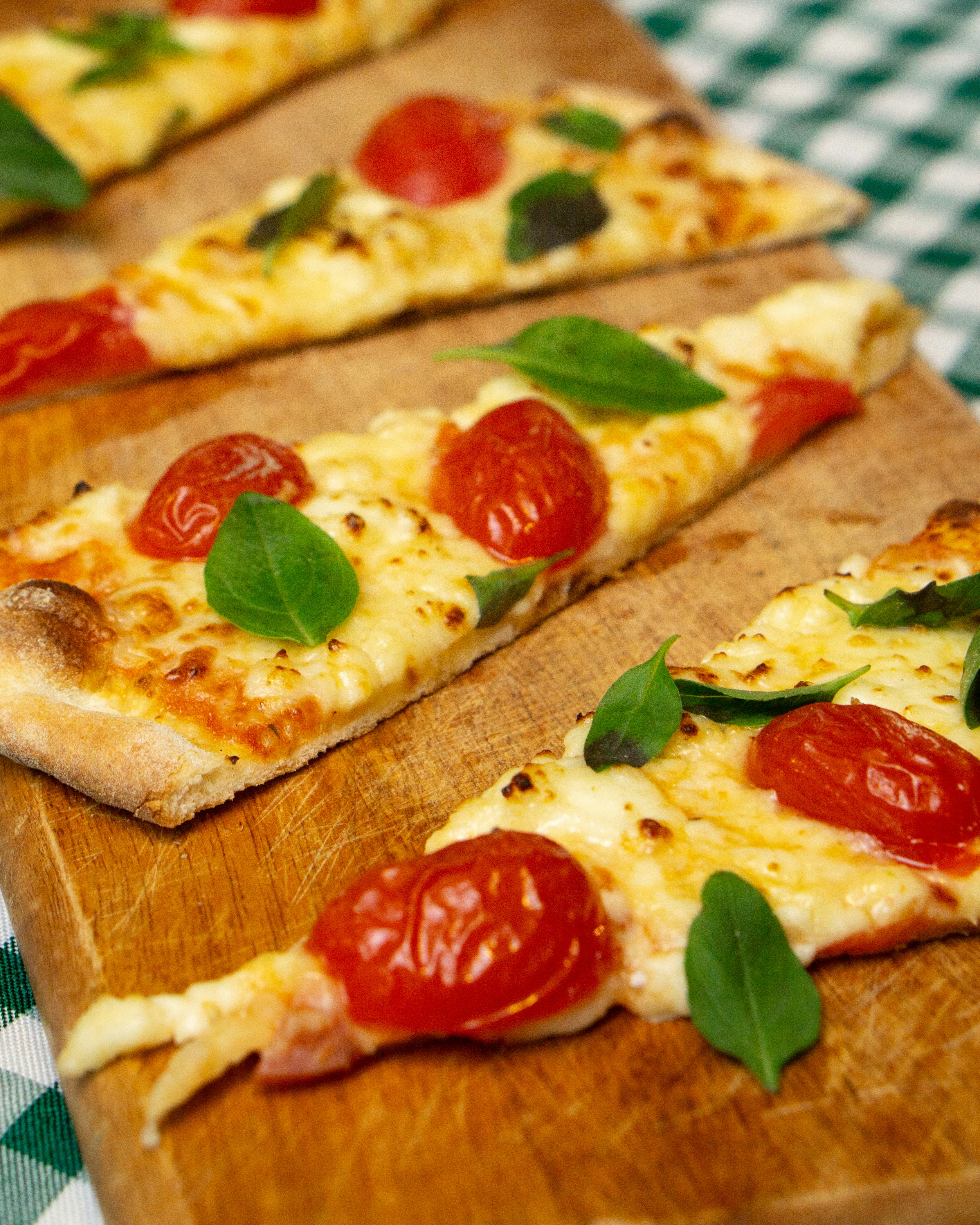 Pizza slices topped with tomatoes and basil. photo – Free Food Image on ...