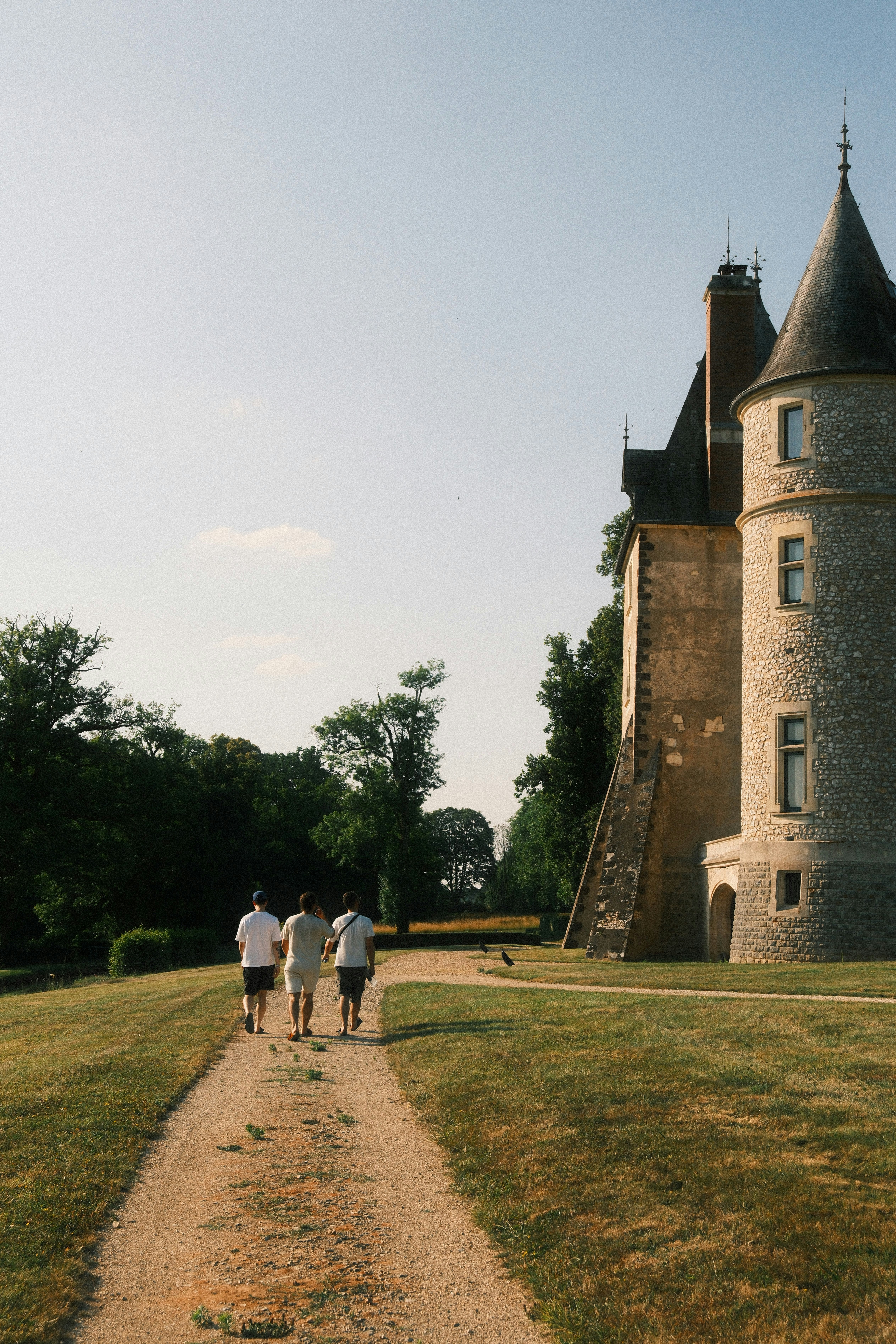 Sunlit Approach to a Turreted Keep: Four on the Gravel Path