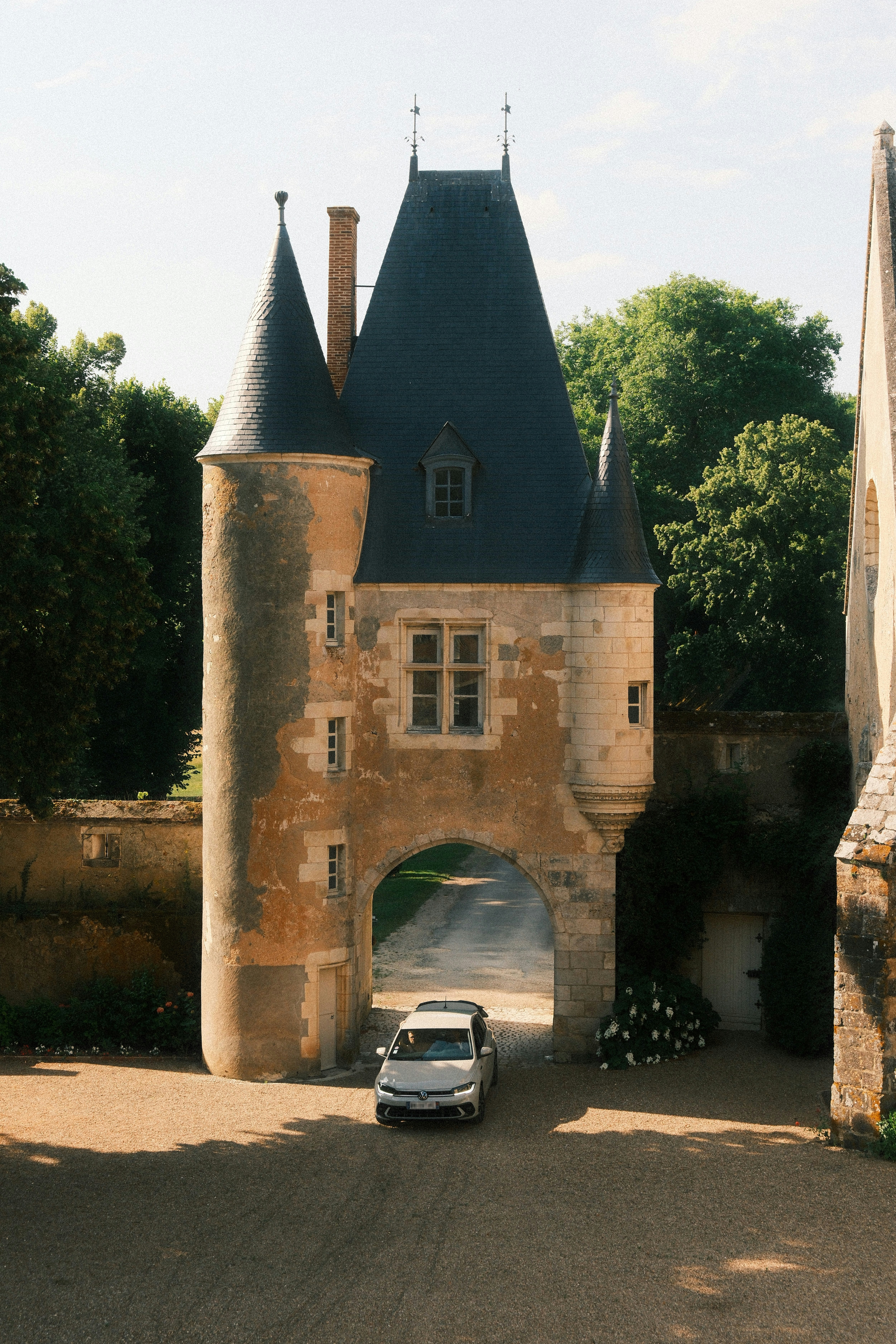 a car going through the entrance of a french castle