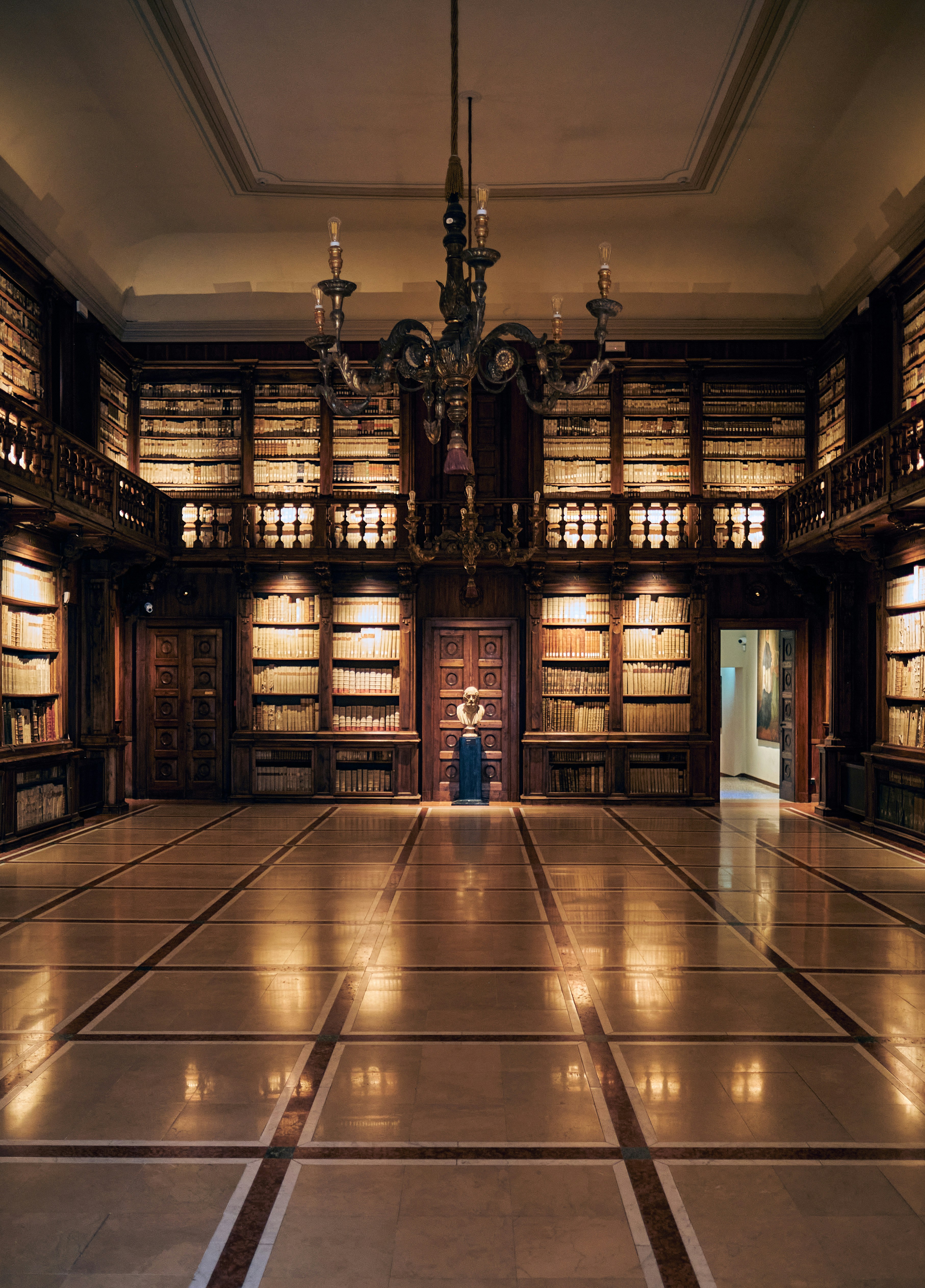 Blue Silhouette at the Heart of a Candlelit Library