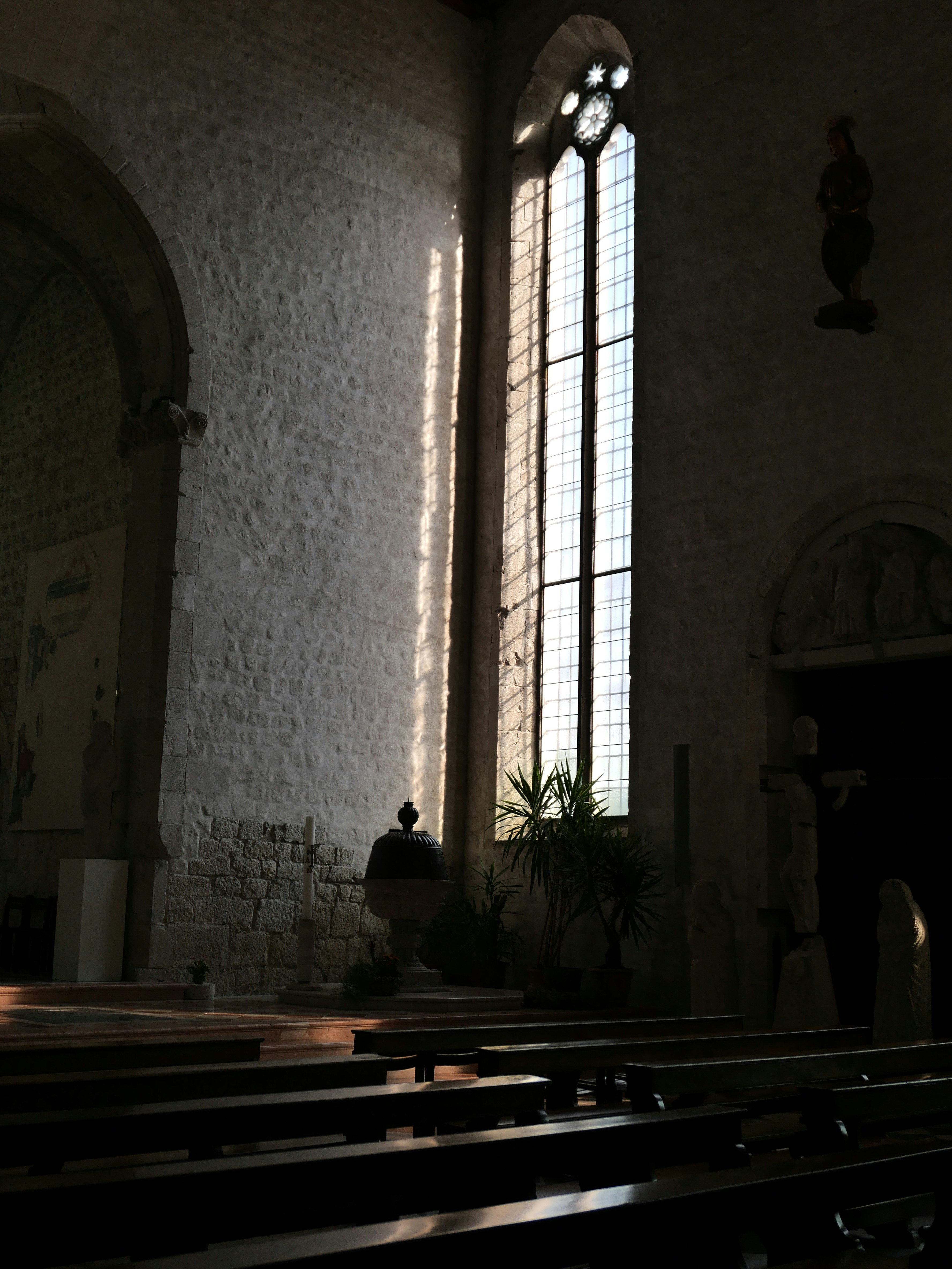Rebuilt | Sunlight streams through a tall church window.