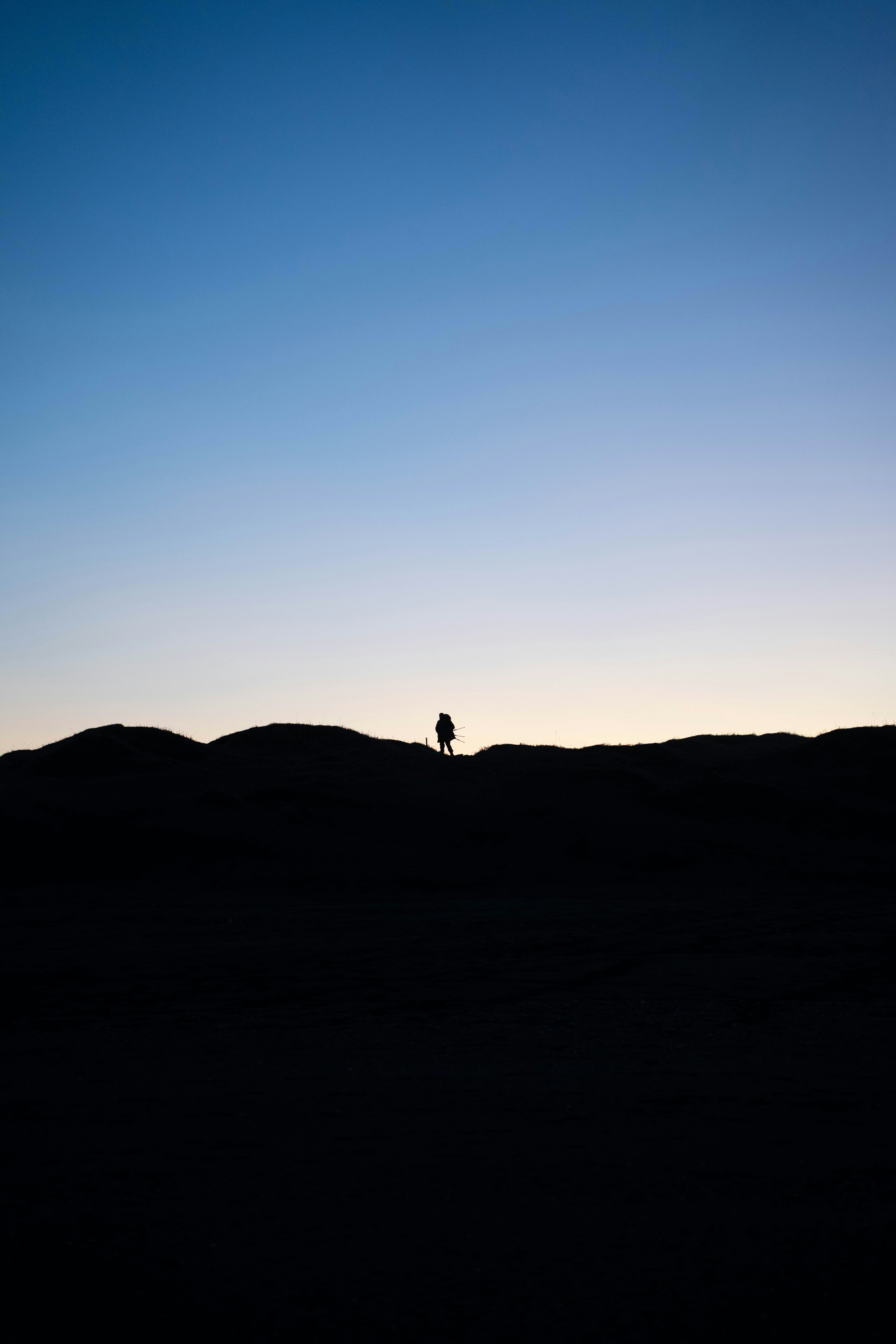 A person silhouetted against a morning sky.