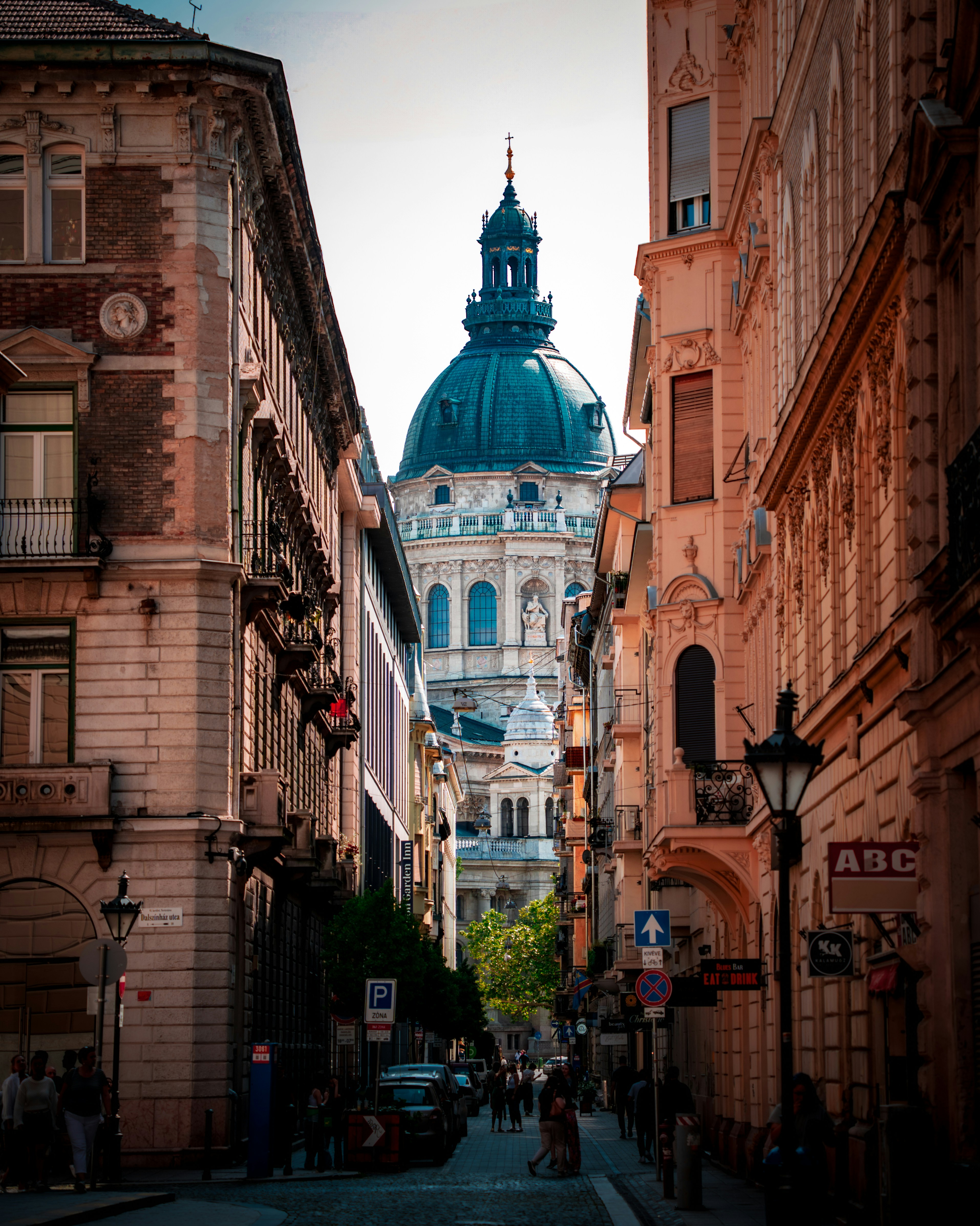 View of St. Stephen's Basilica framed by narrow streets, highlighting the architectural details of the surrounding buildings. The scene captures the essence of urban exploration.