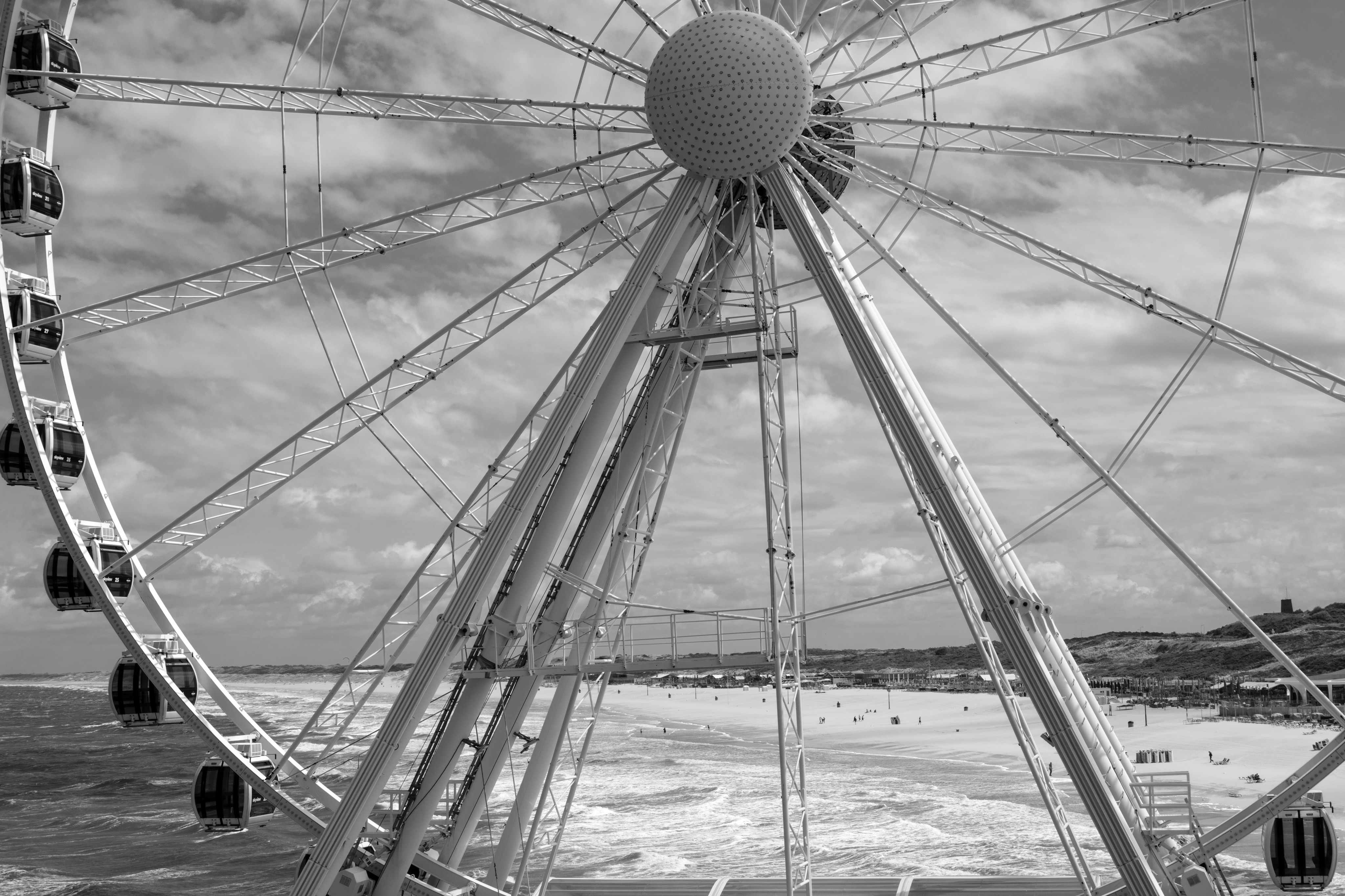 A ferris wheel offers a seaside view.