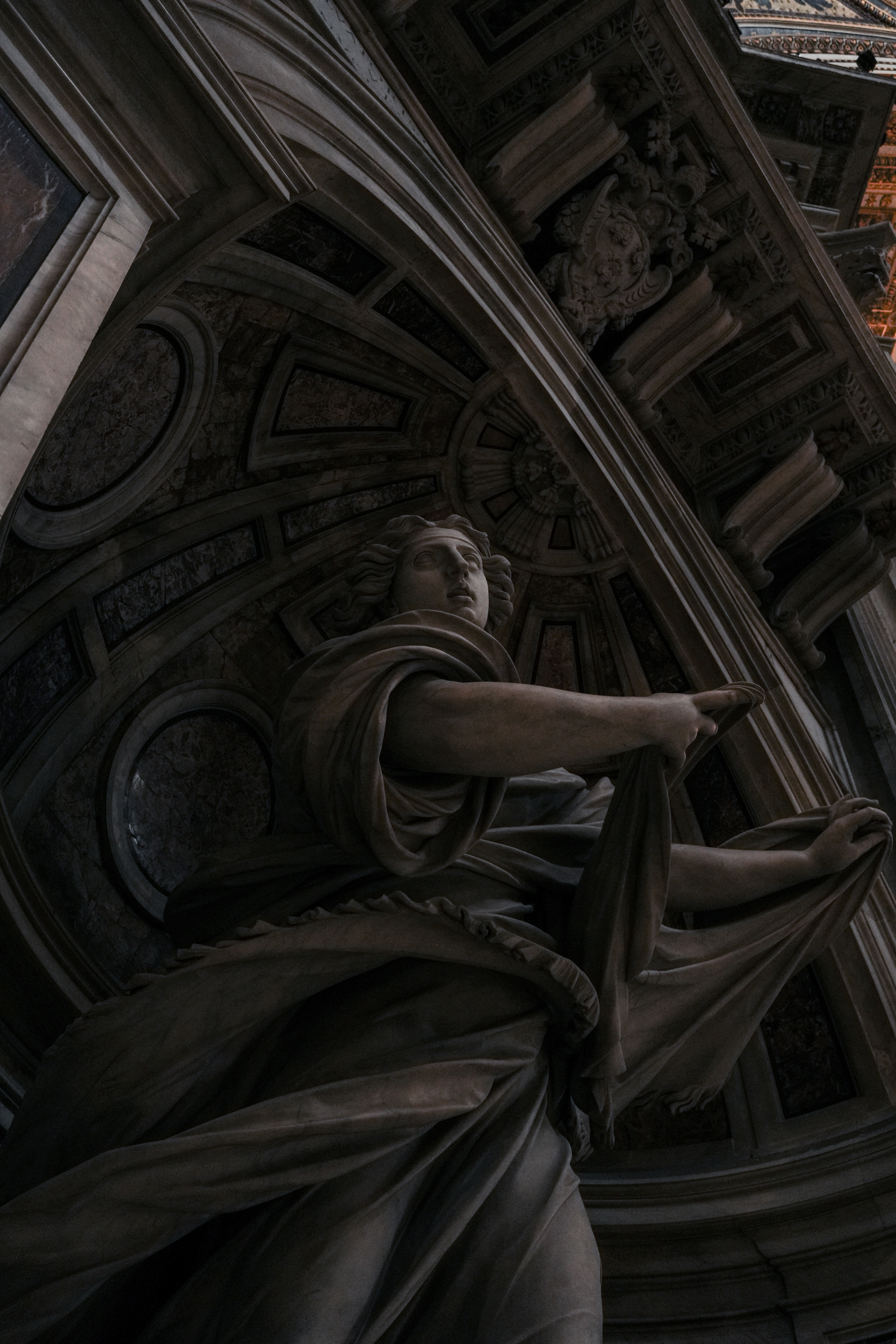 A statue points upward in an ornate building. photo – Free Portrait ...