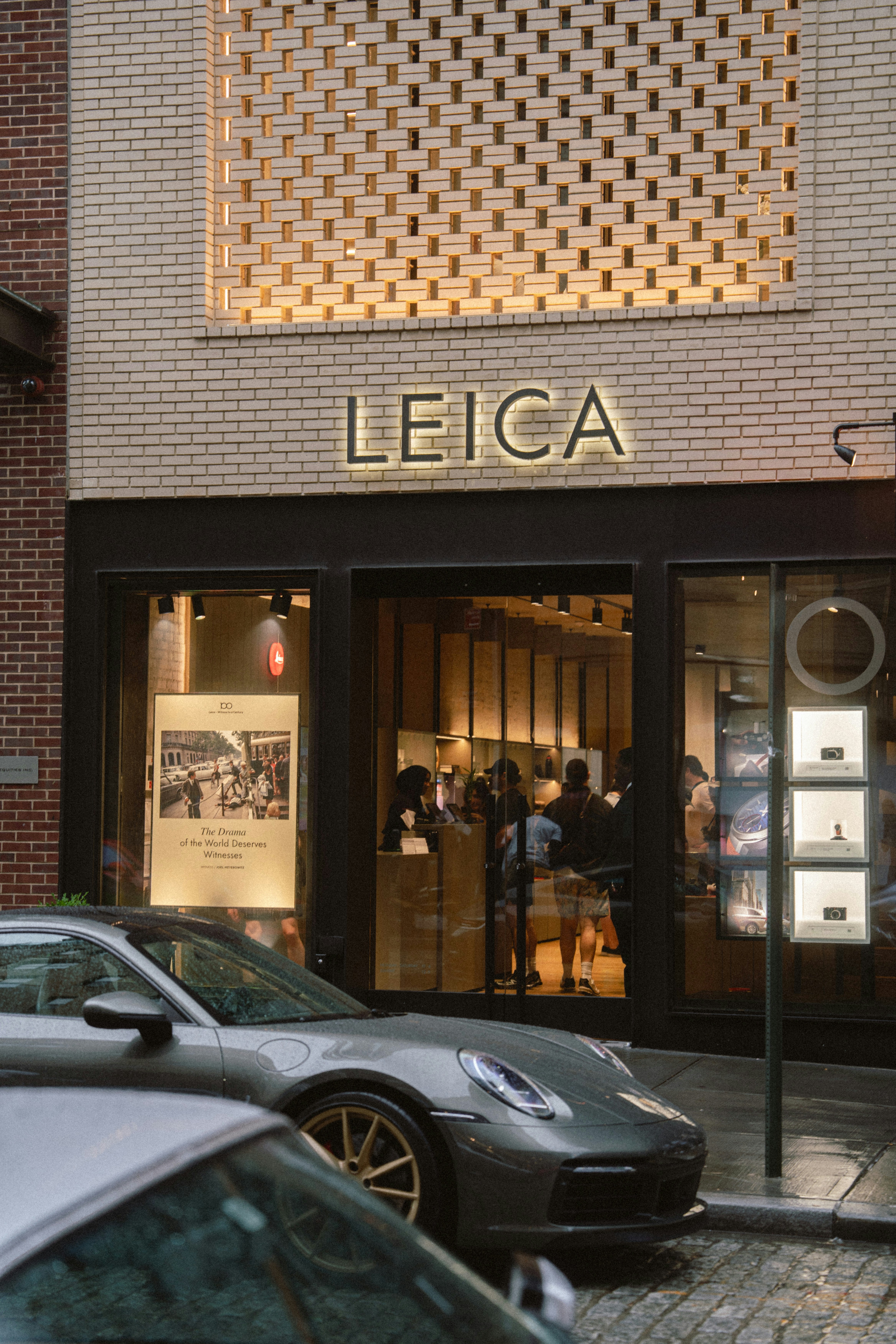 The leica store is pictured from outside with a car. photo – Free Cars ...